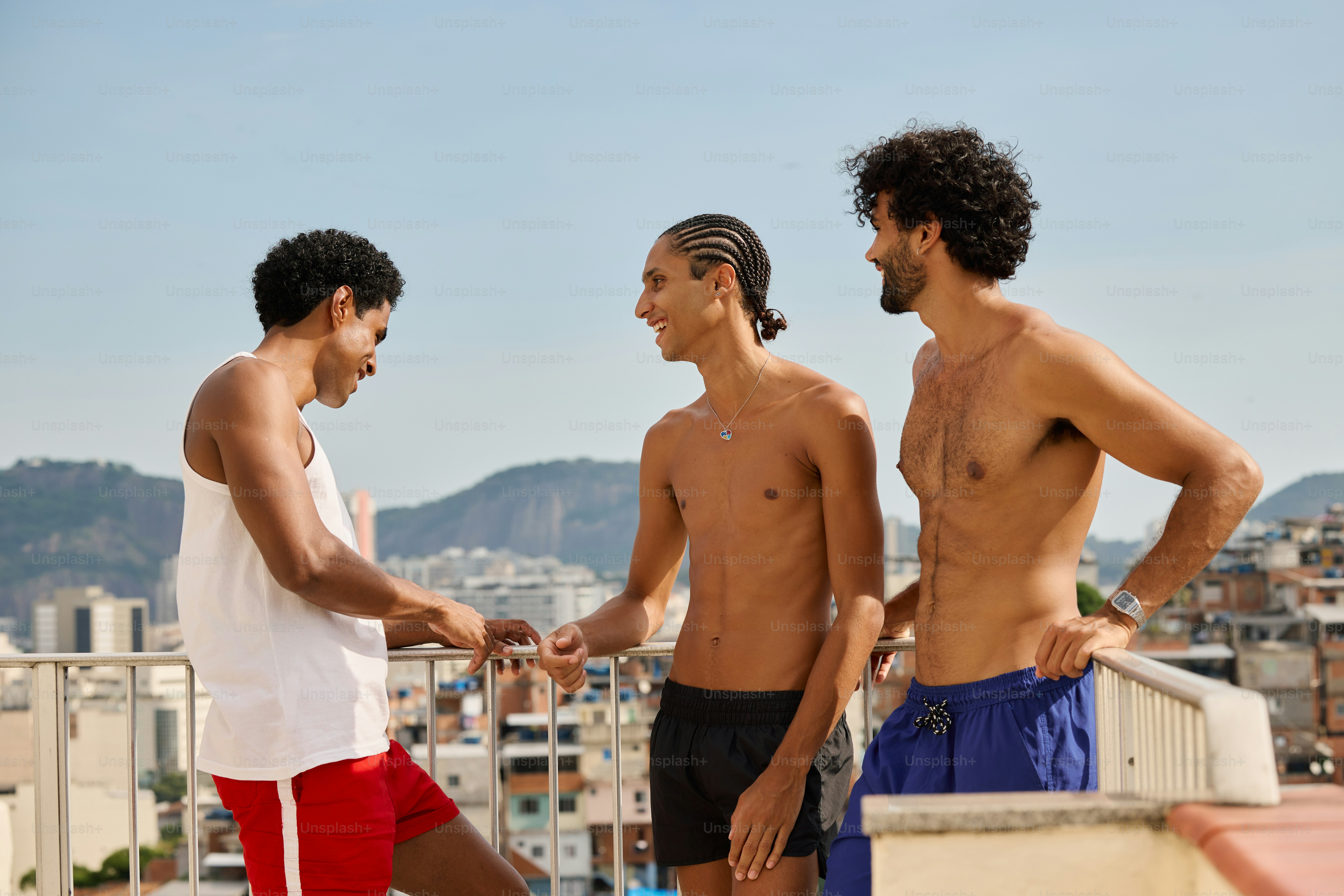 A group of three men standing next to each other photo – Fashion Image ...