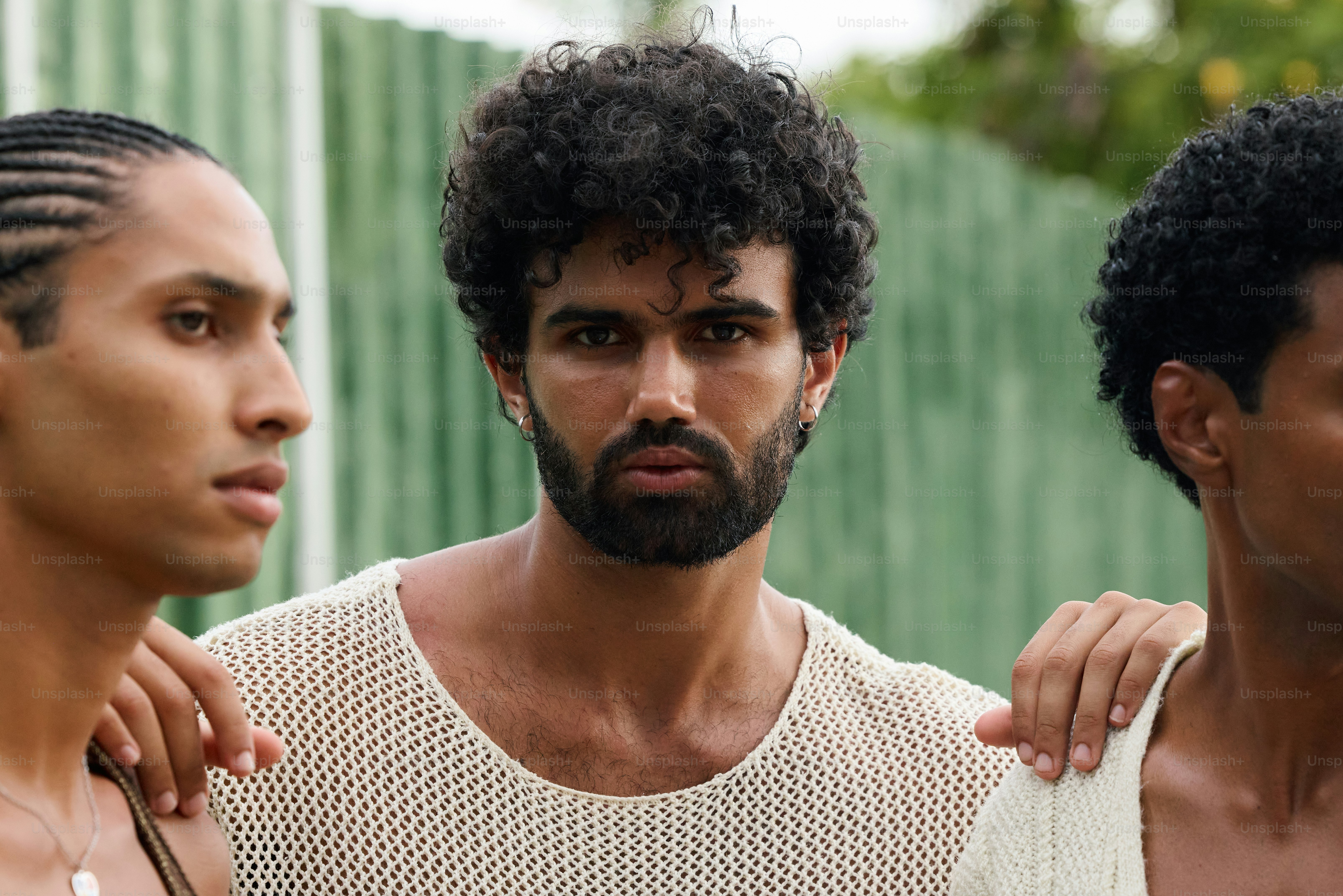 A group of three men standing next to each other photo – Bonding Image ...