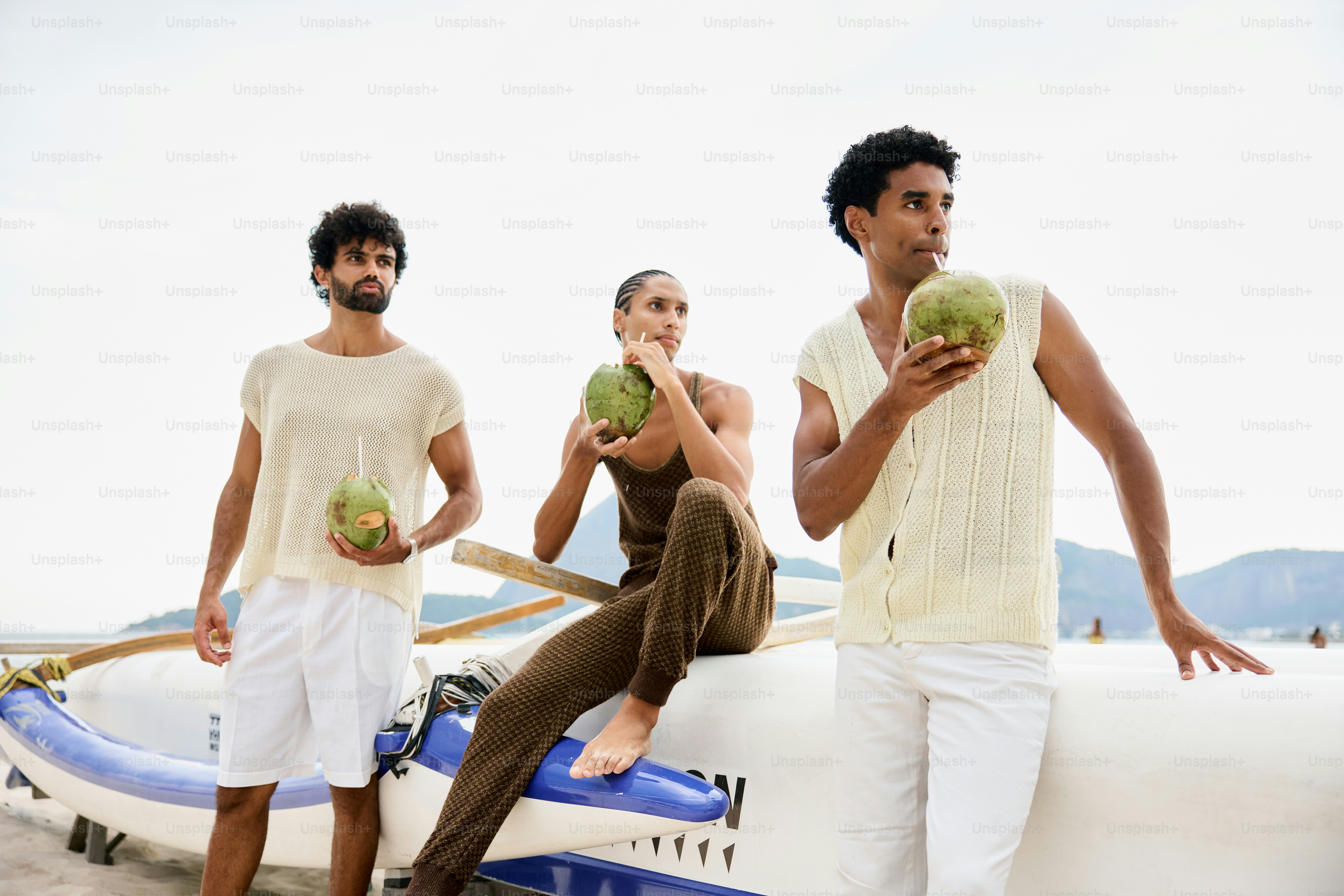 A group of three men standing next to each other photo – Fashion Image ...