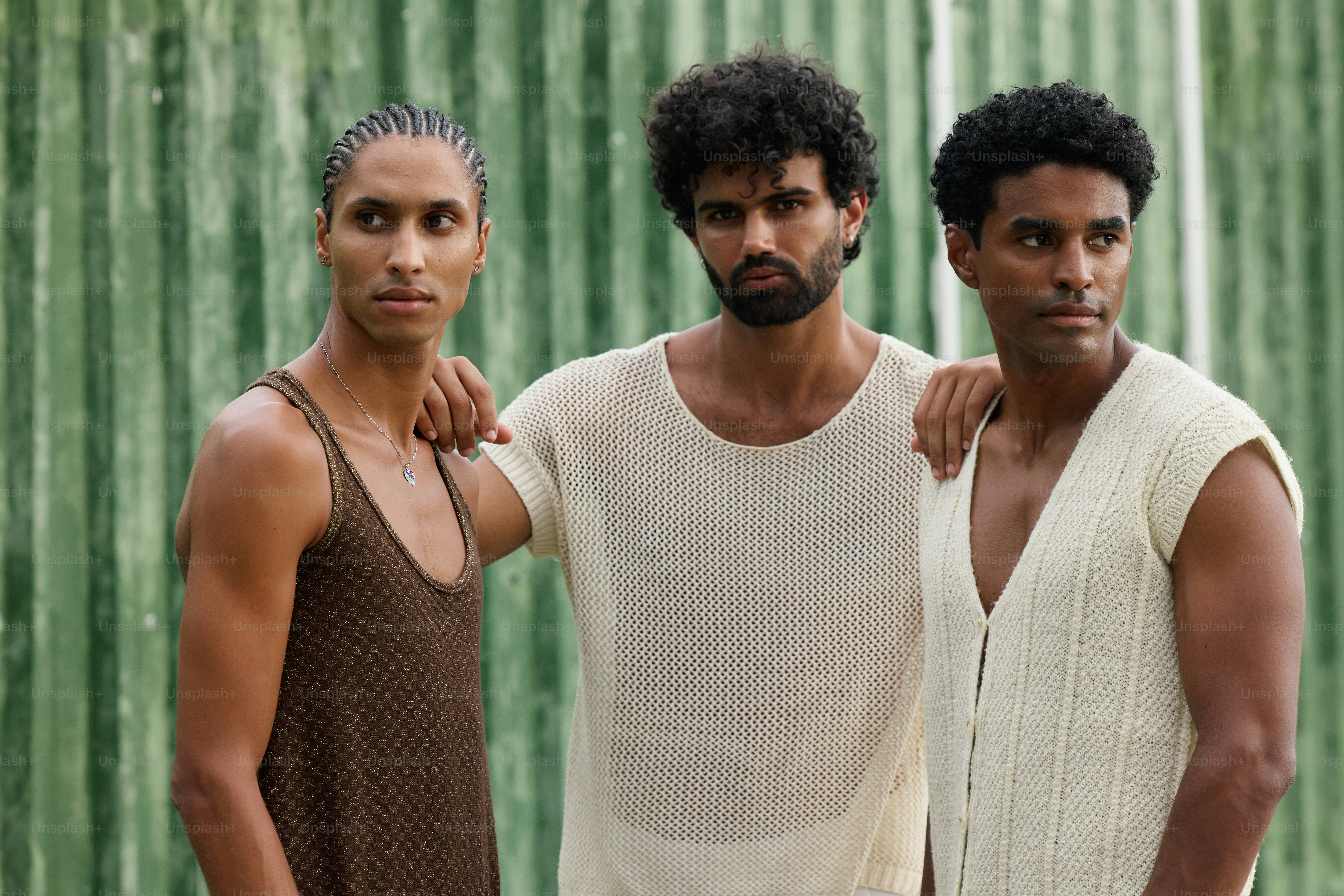 A group of three men standing next to each other photo – Elegance Image ...
