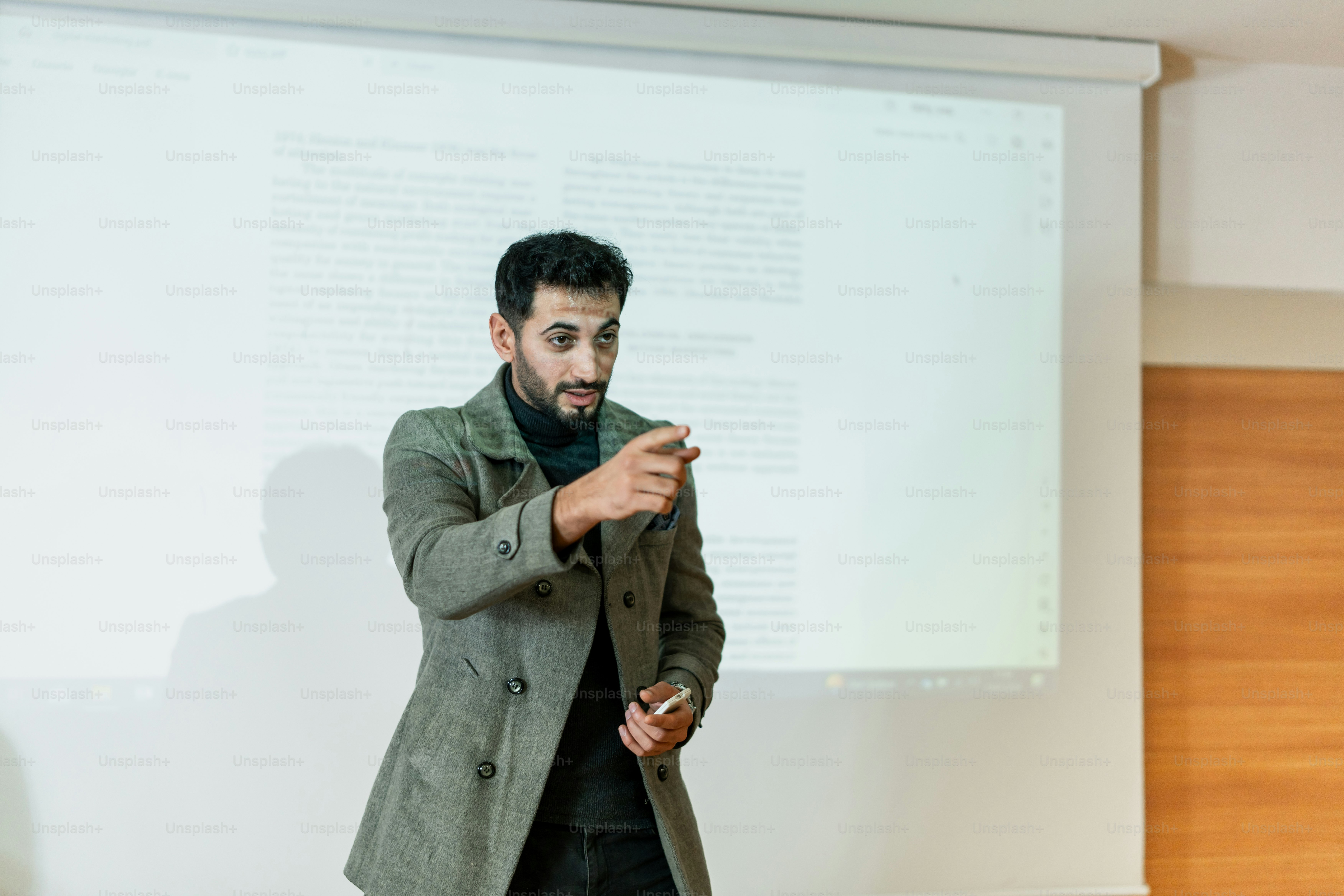 A man standing in front of a projection screen photo – Public speaking ...