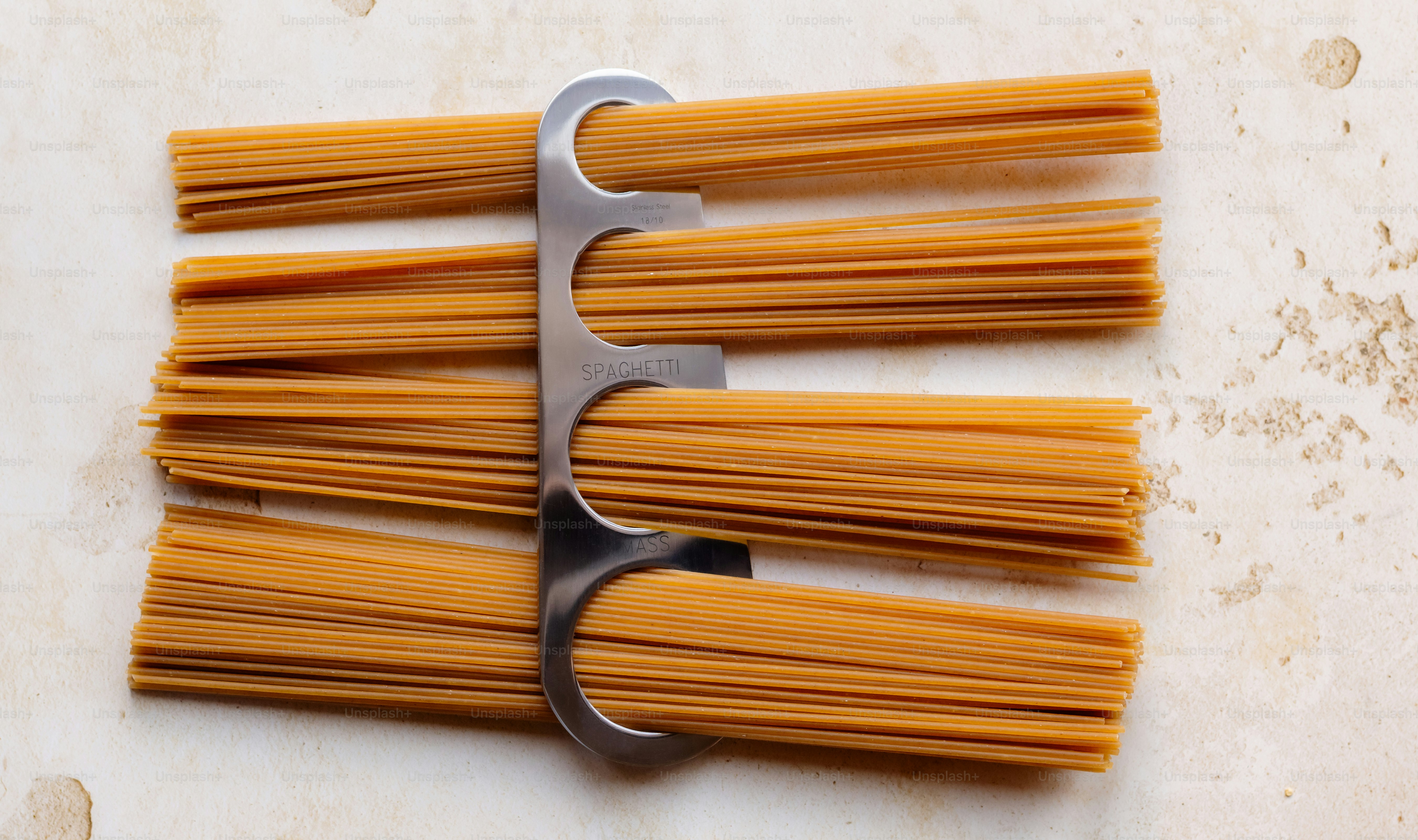 A bunch of pasta being cut with a scissor photo – Whole grain pasta ...