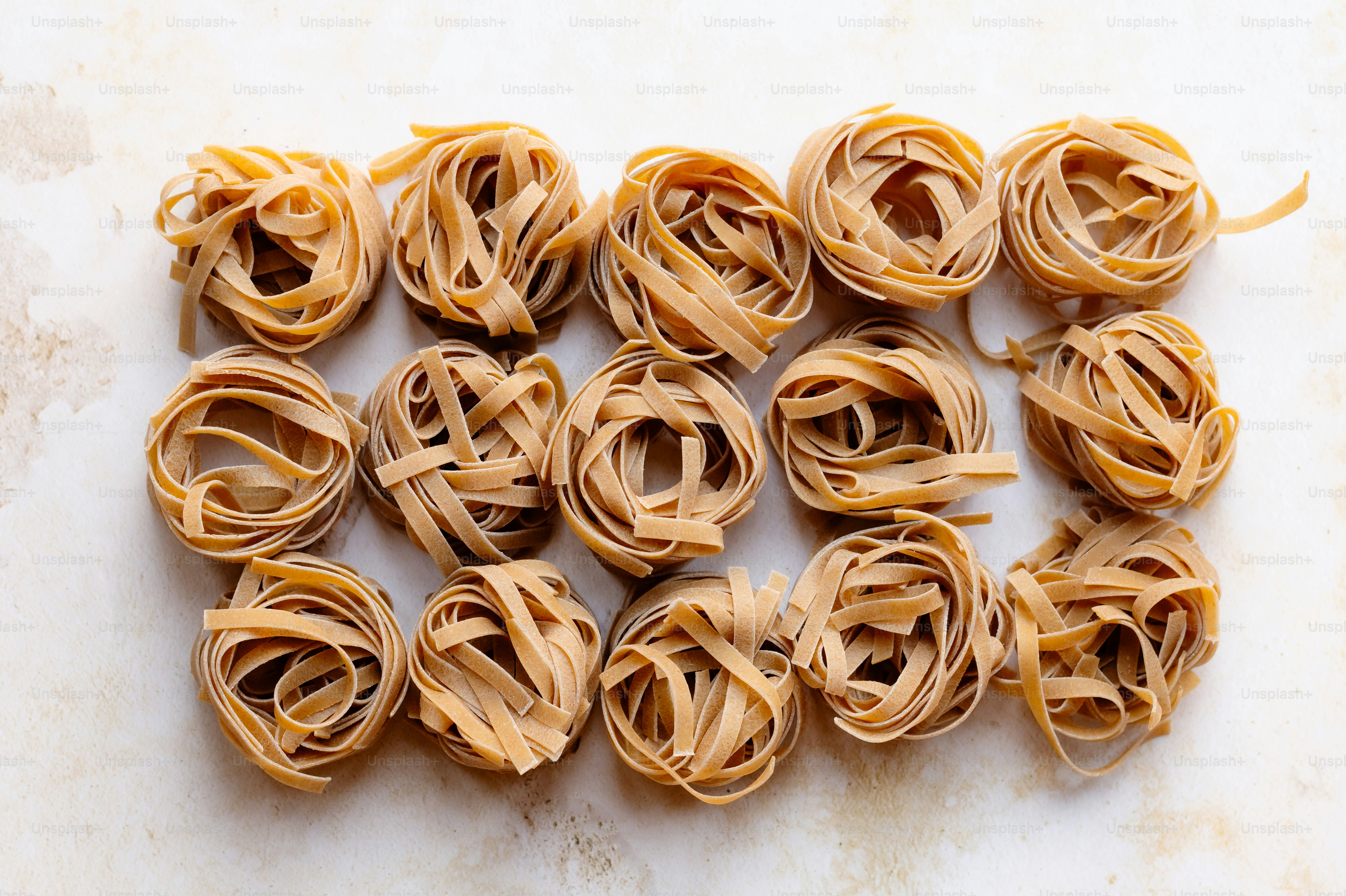 A bunch of pasta being cut with a scissor photo – Whole grain pasta ...
