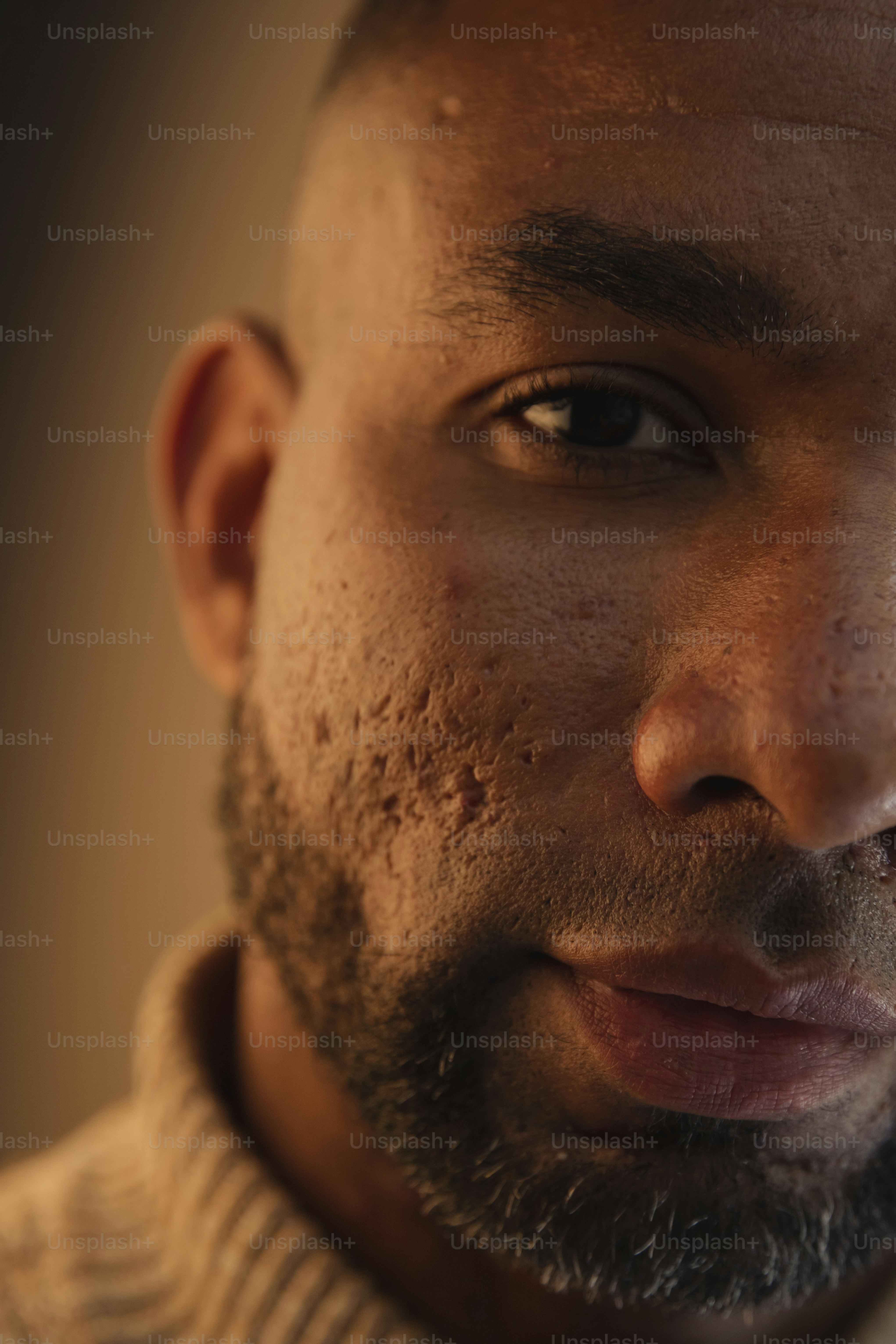 A close up of a man wearing a sweater photo – Acne scars Image on Unsplash