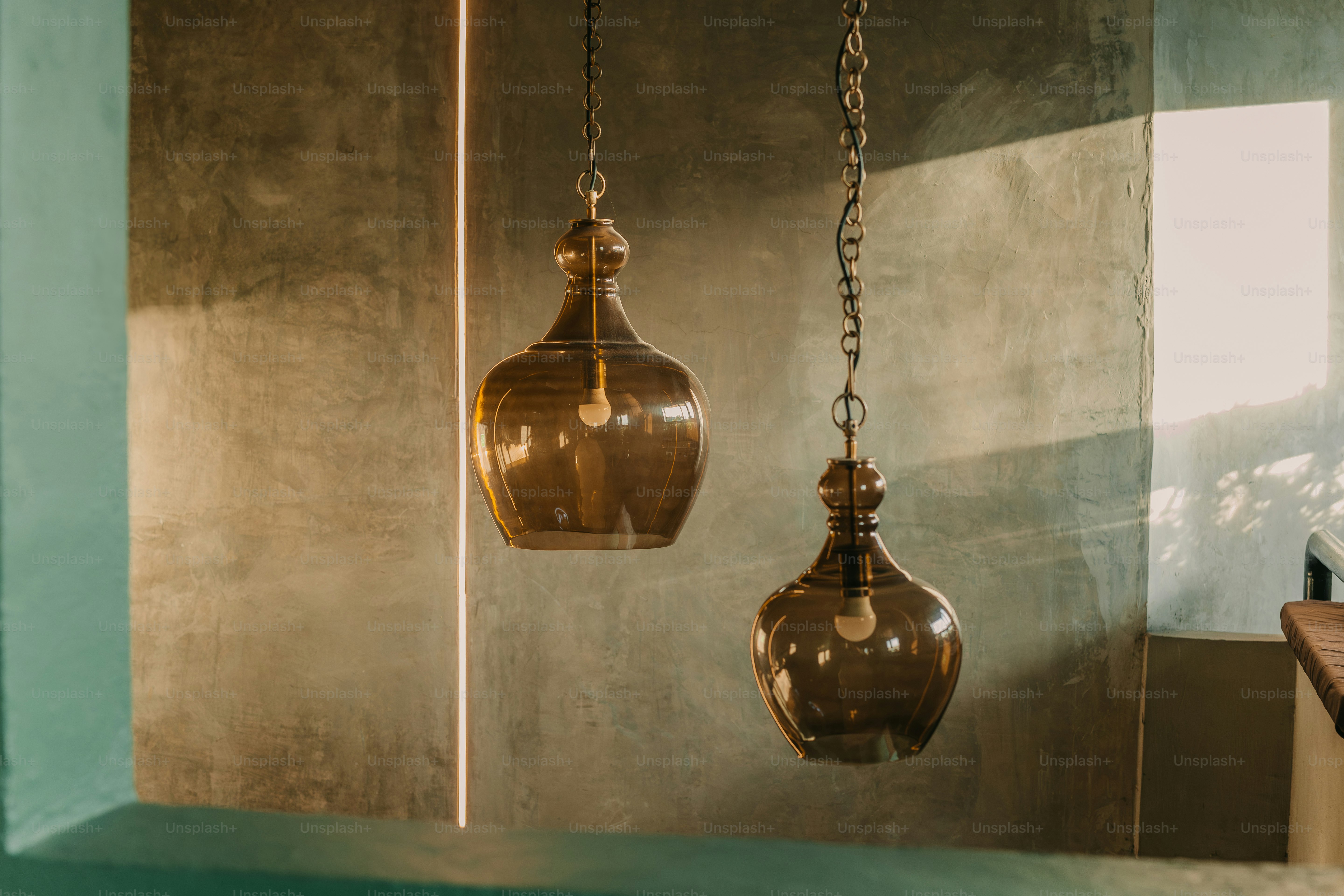 A couple of lights hanging from a ceiling photo – Lightbulb Image on ...