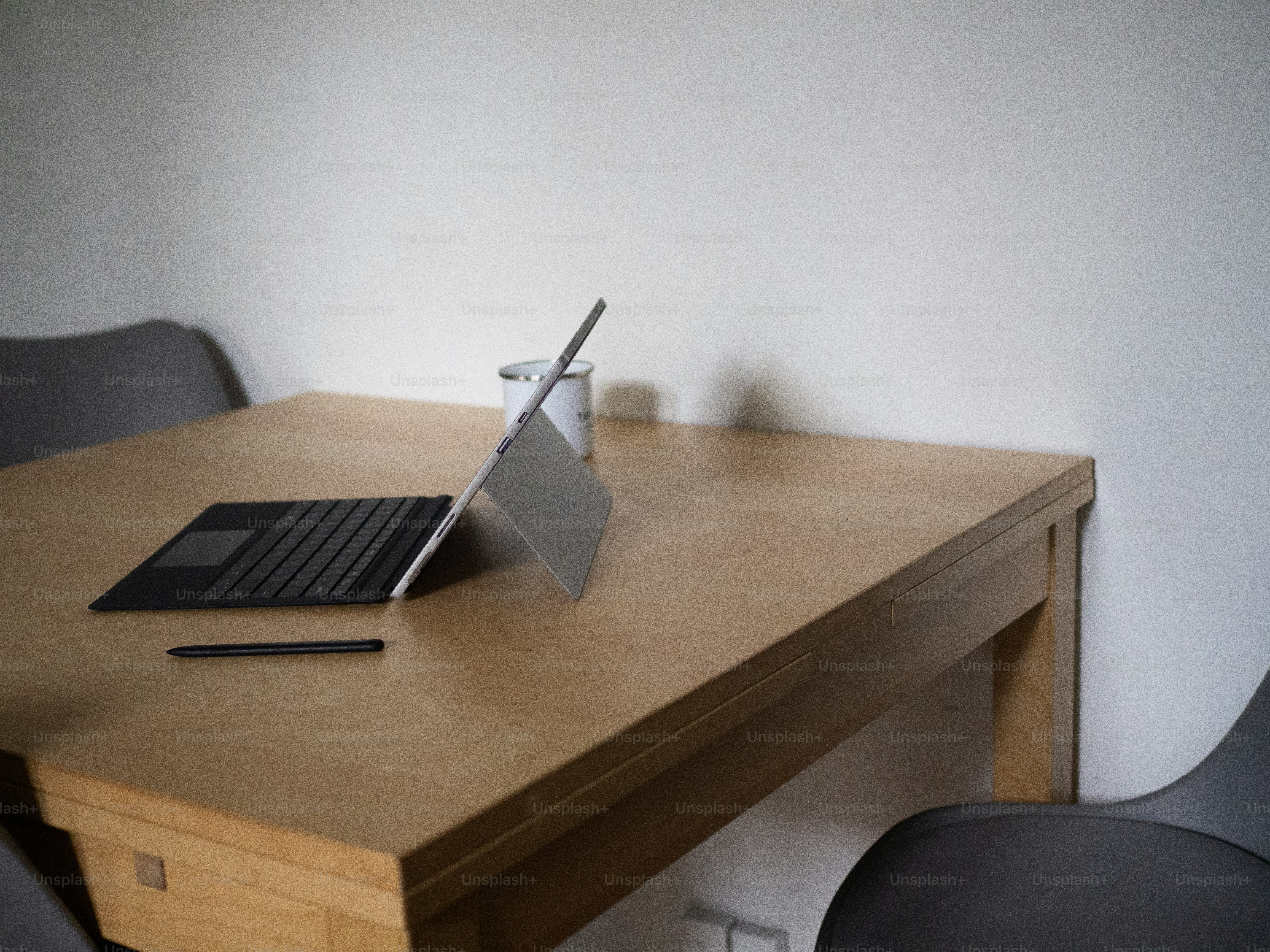 A laptop computer sitting on top of a wooden desk photo – Keyboard ...