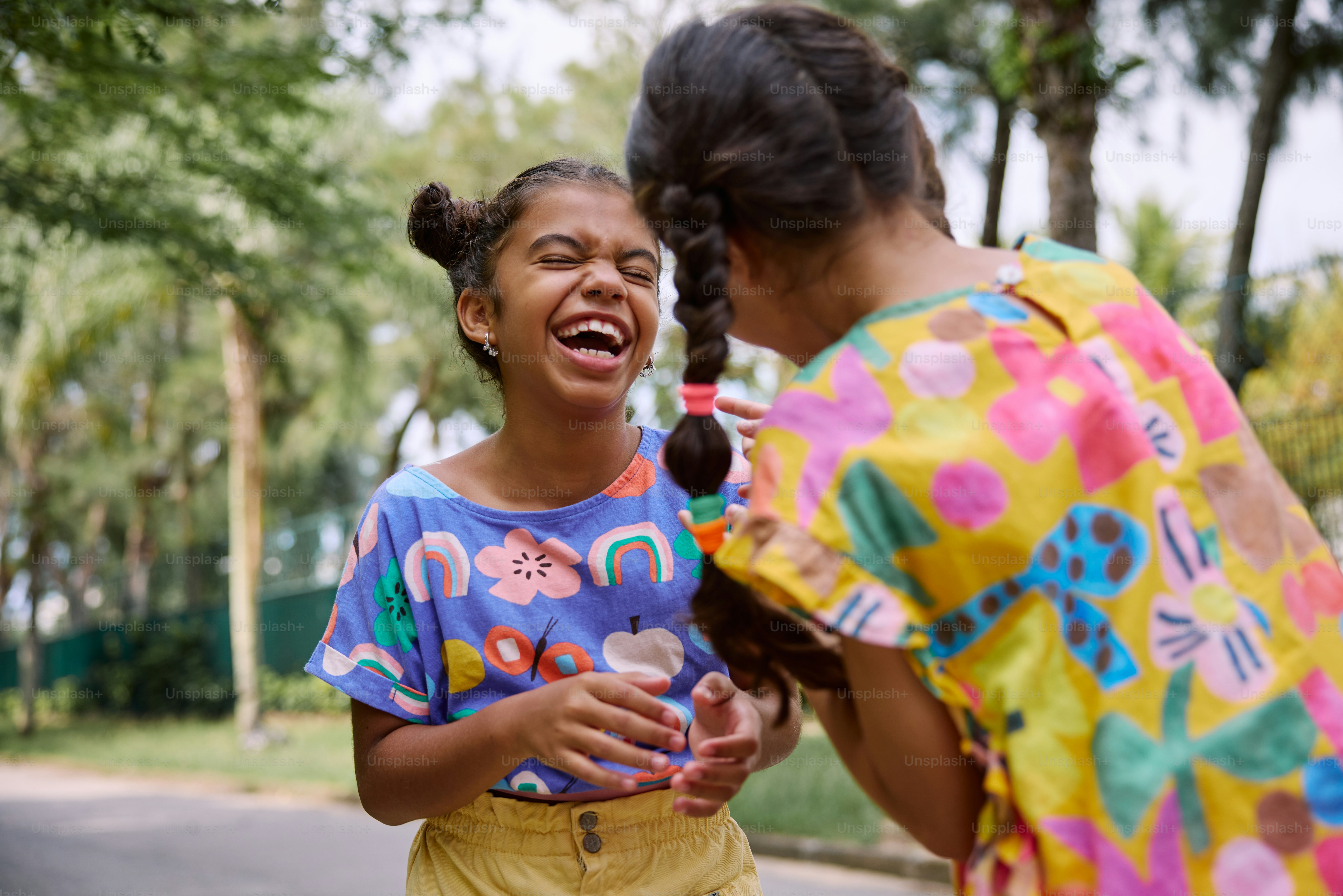 Two girls laughing and laughing at each other photo – Hopscotch Image ...