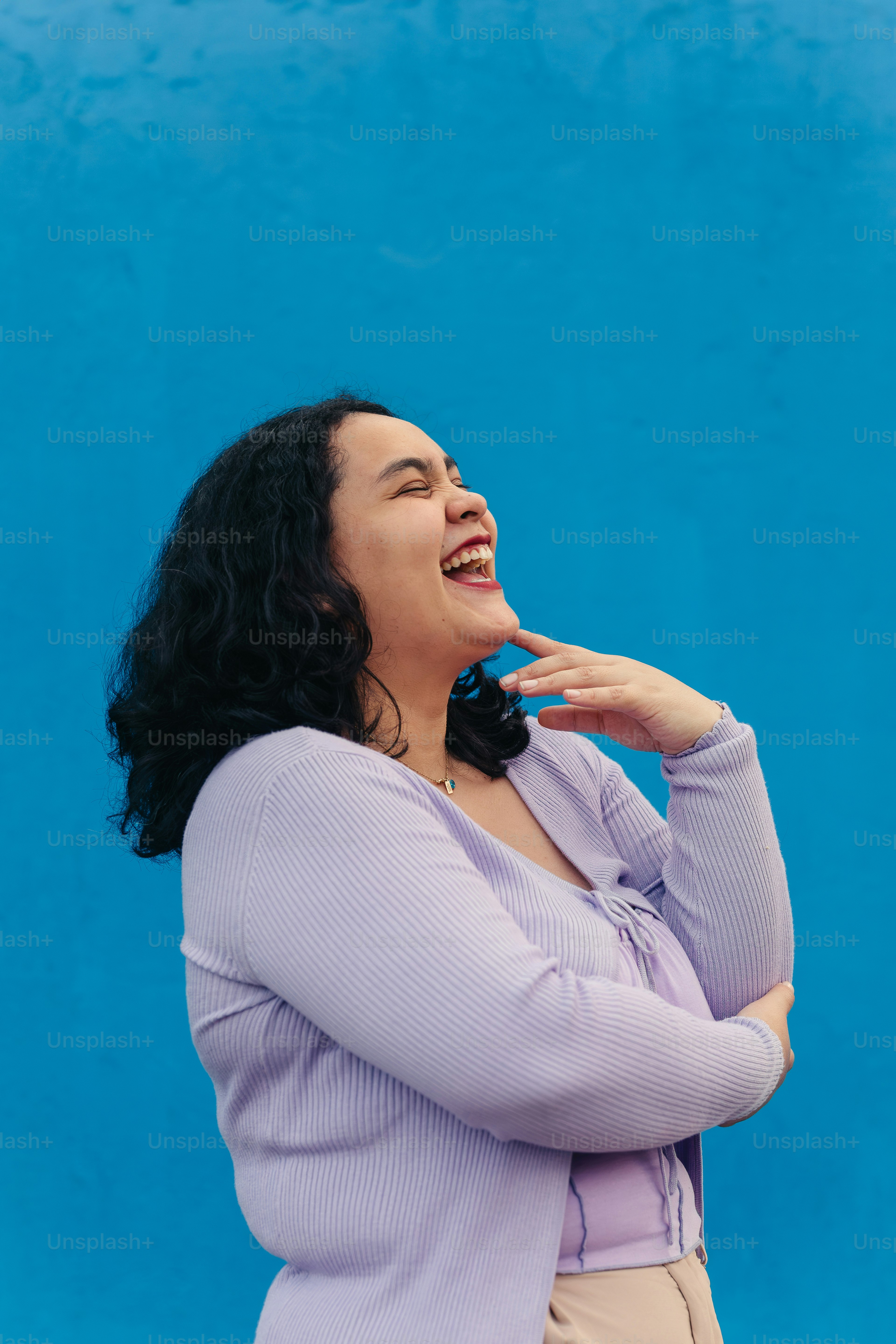 A woman is laughing while talking on a cell phone photo – Laugh Image ...