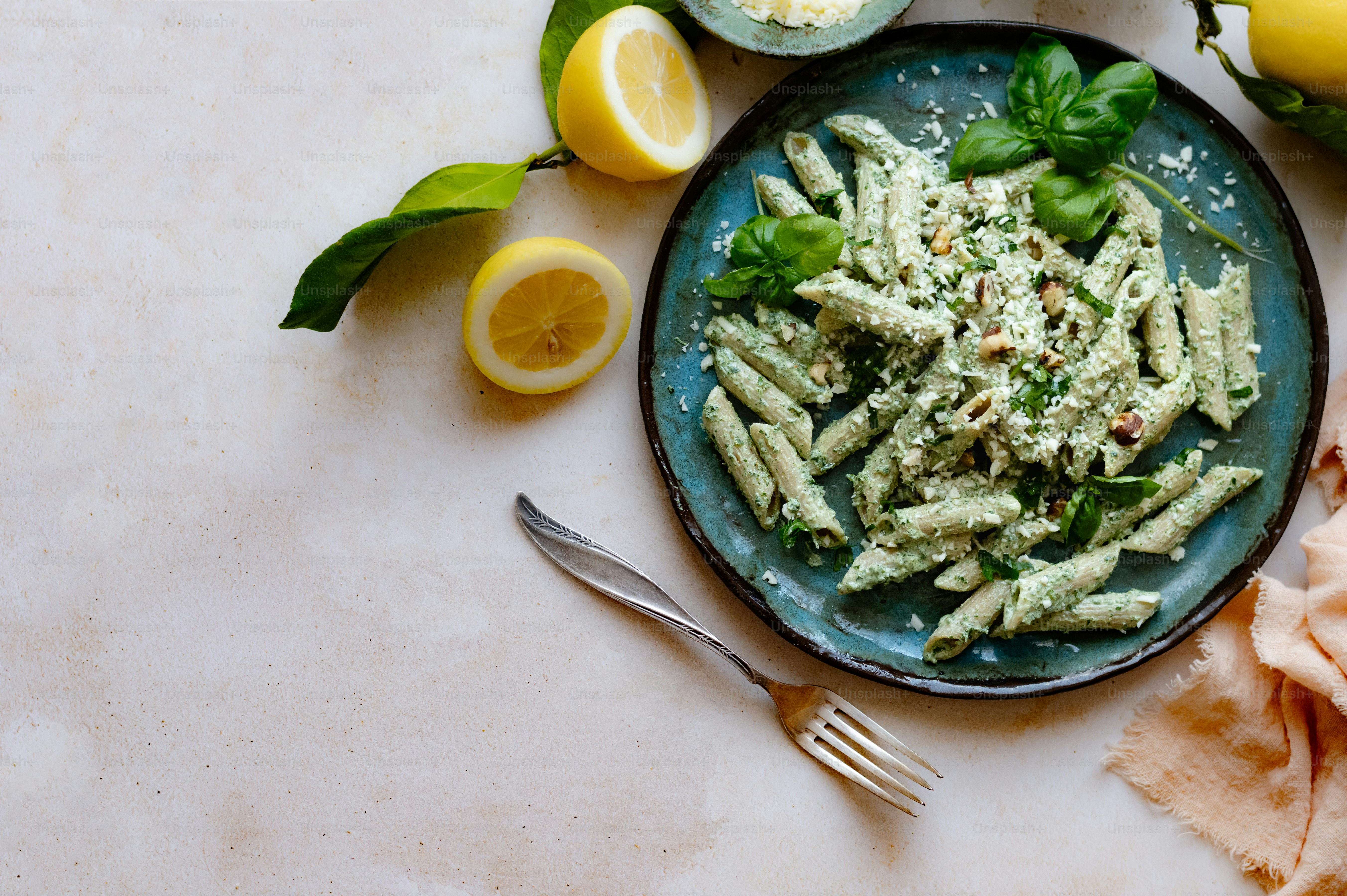 A plate of pasta with pesto and lemons photo – Food Image on Unsplash