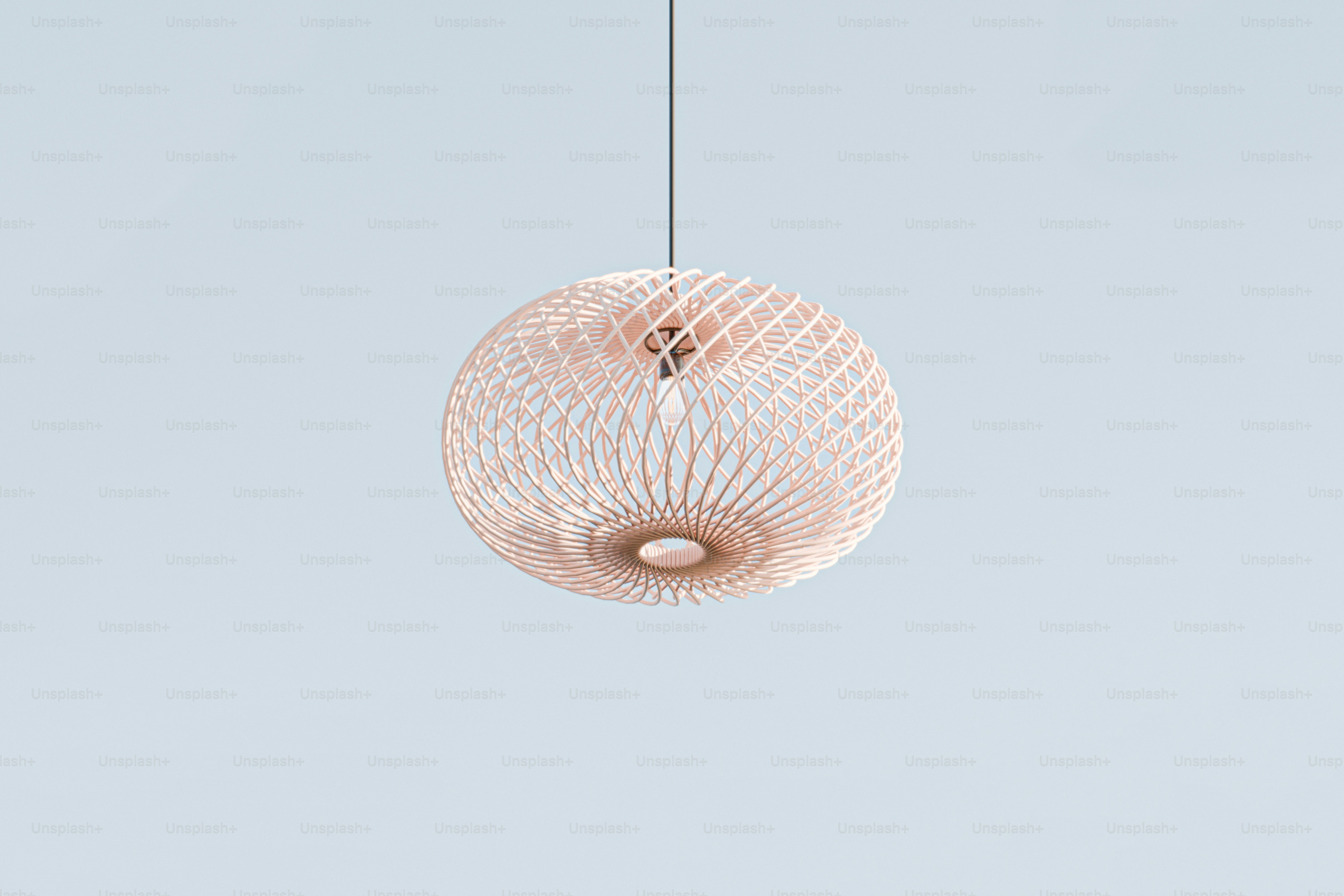 A white light fixture hanging from a wire photo – Pendant lighting ...