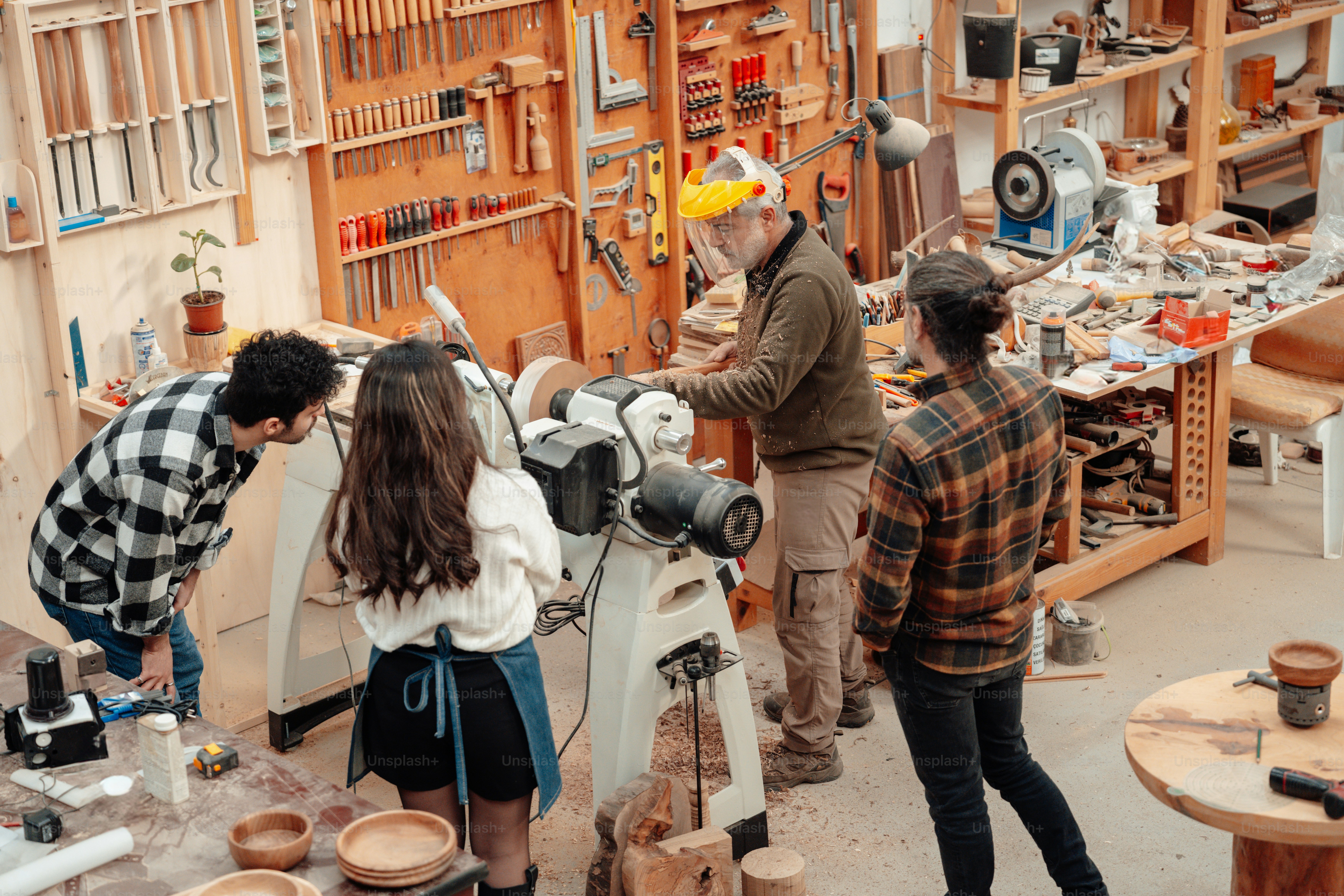 A group of people working in a wood shop photo – Studio Image on Unsplash