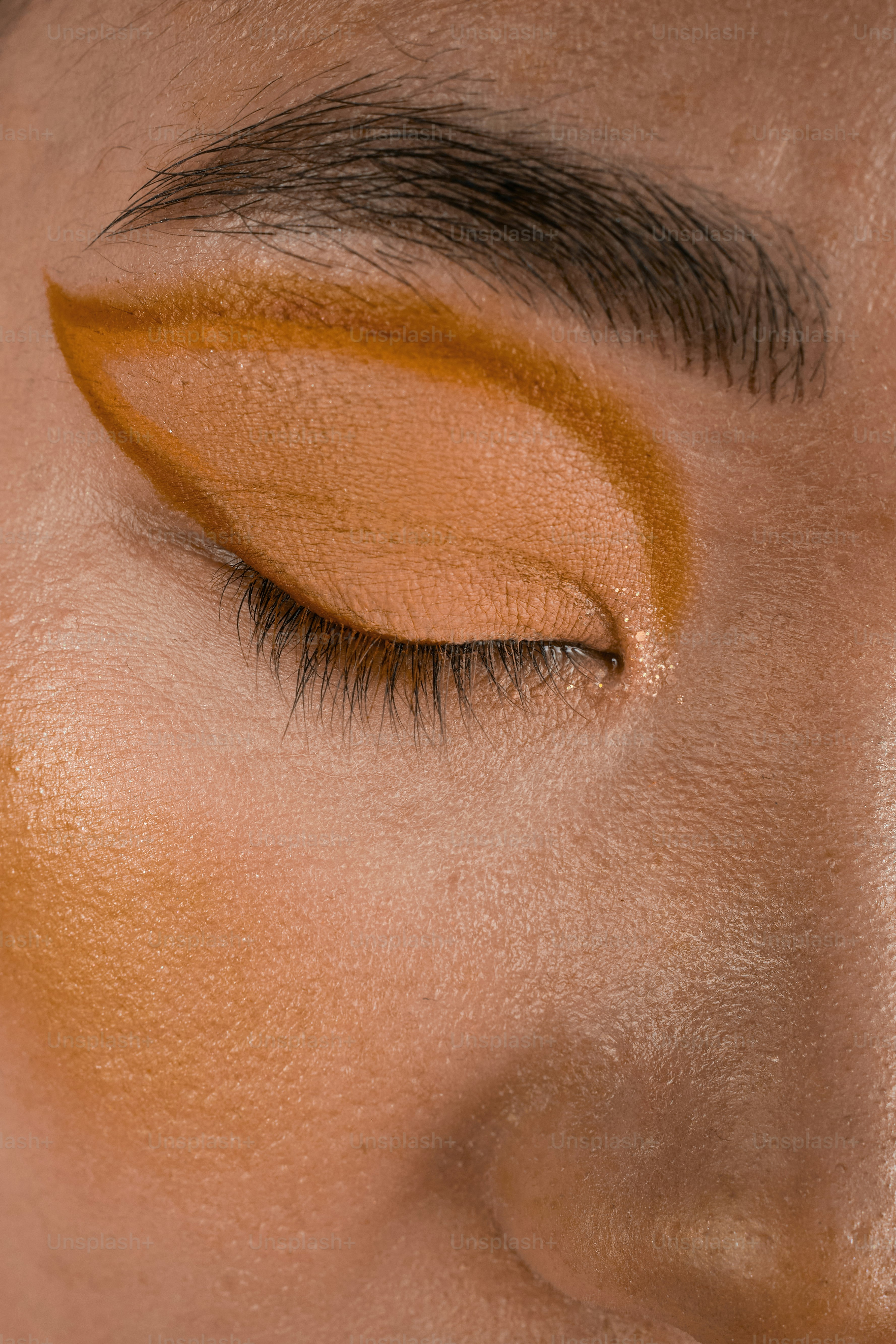 A close up of a woman's face with a yellow eye shadow photo – Peach ...