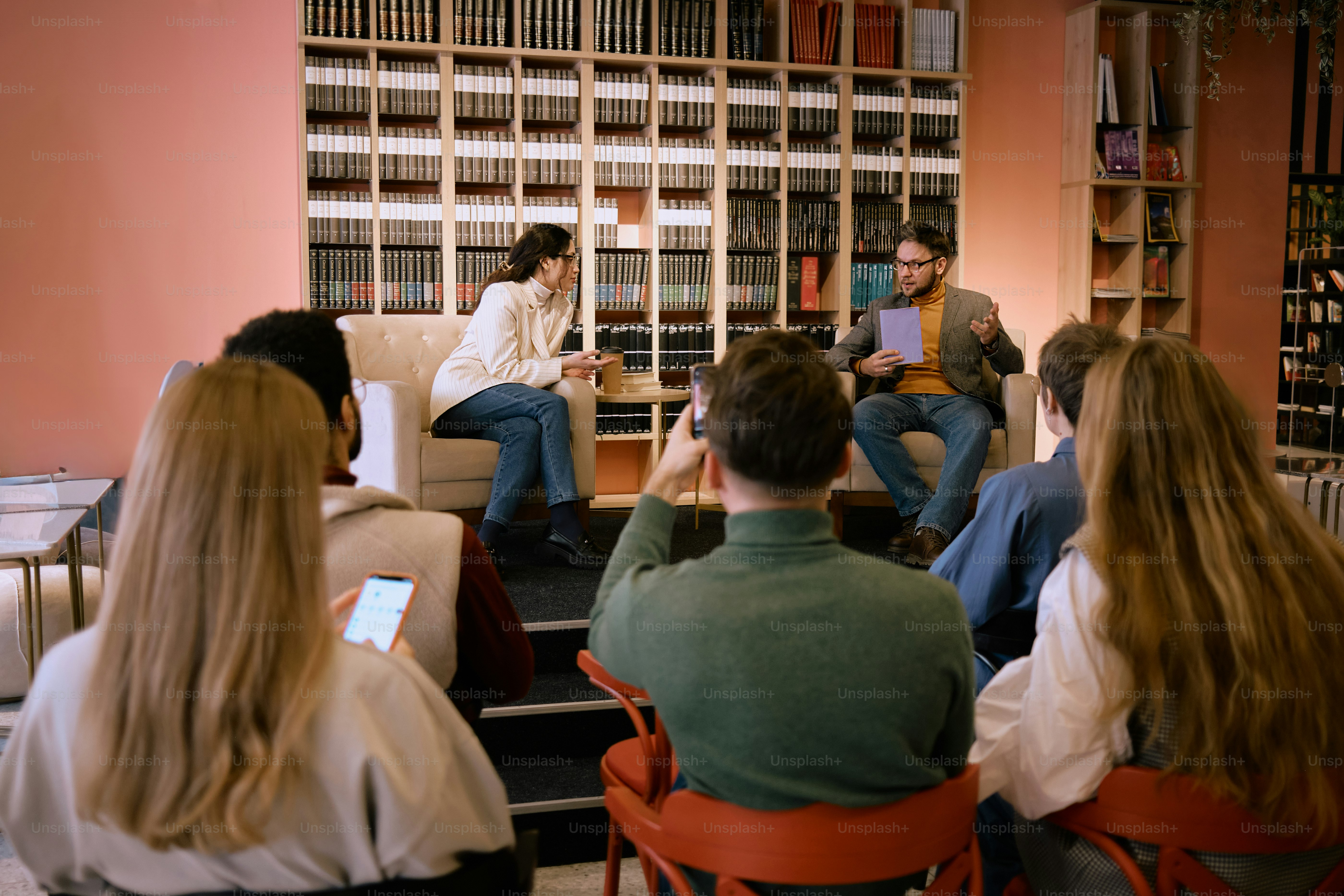 A group of people sitting in a room photo – Book club Image on Unsplash