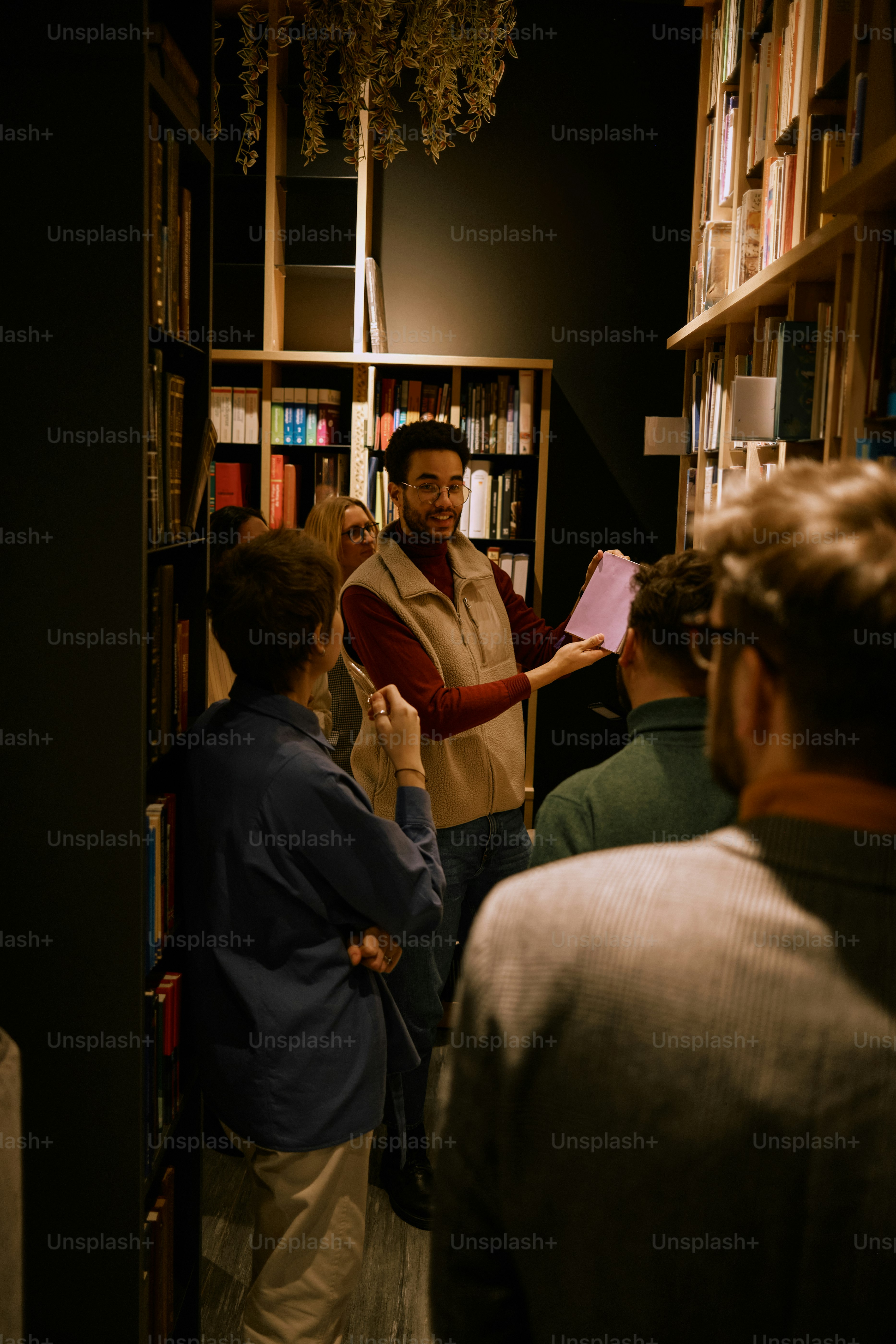 A group of people standing around a library photo – Community Image on ...