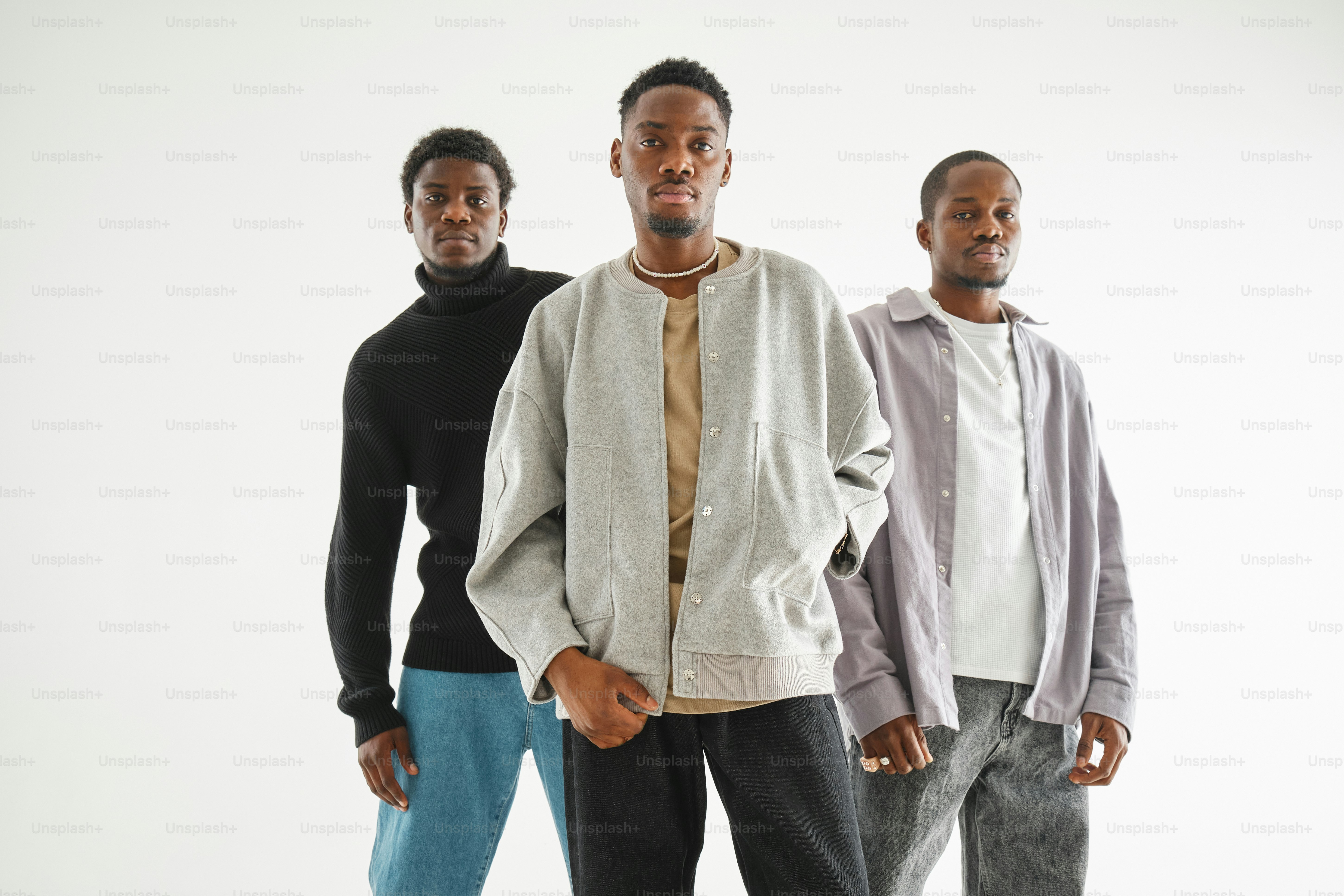A group of three men standing next to each other photo – Black Image on ...