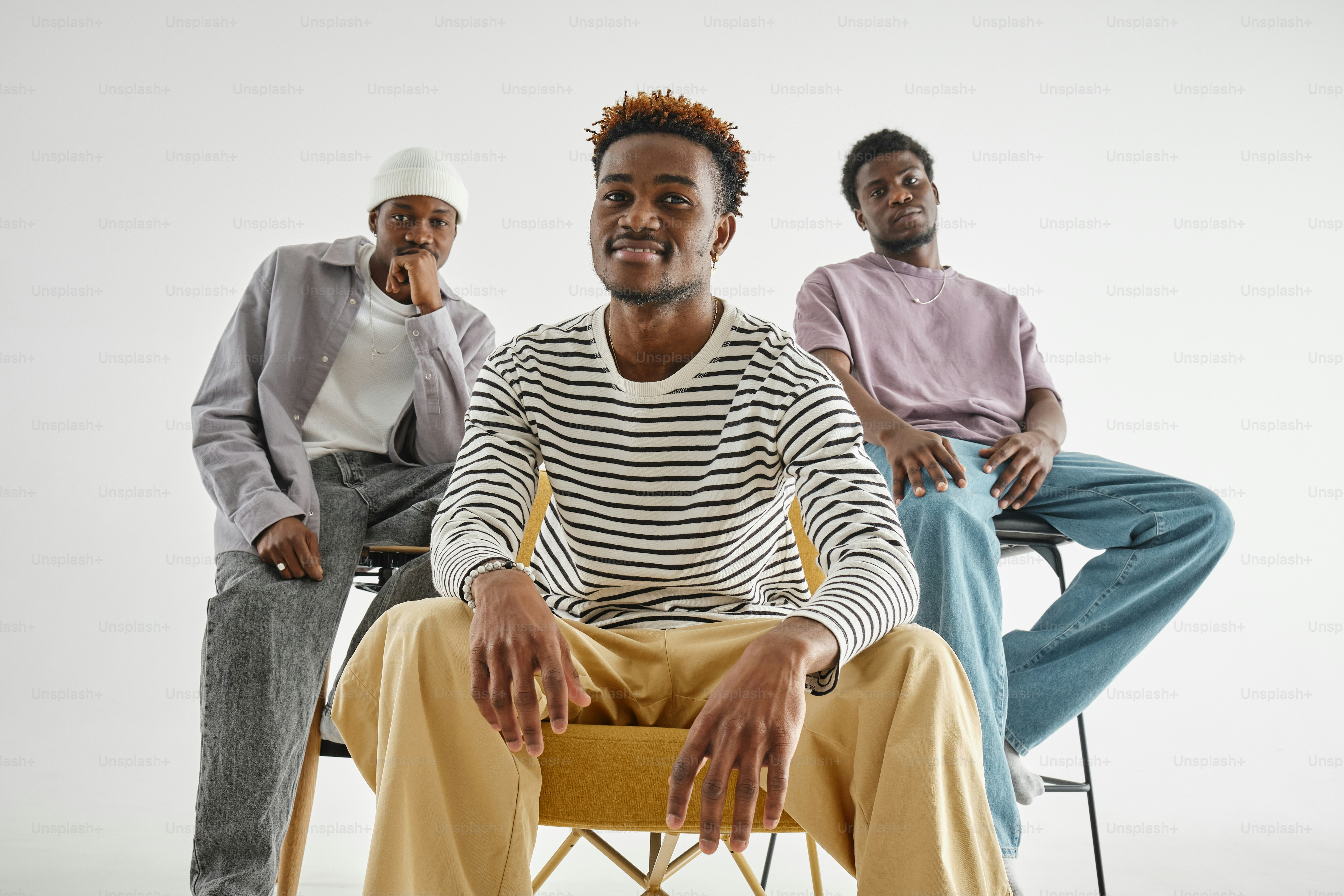 A group of three men sitting next to each other photo – Brotherhood ...