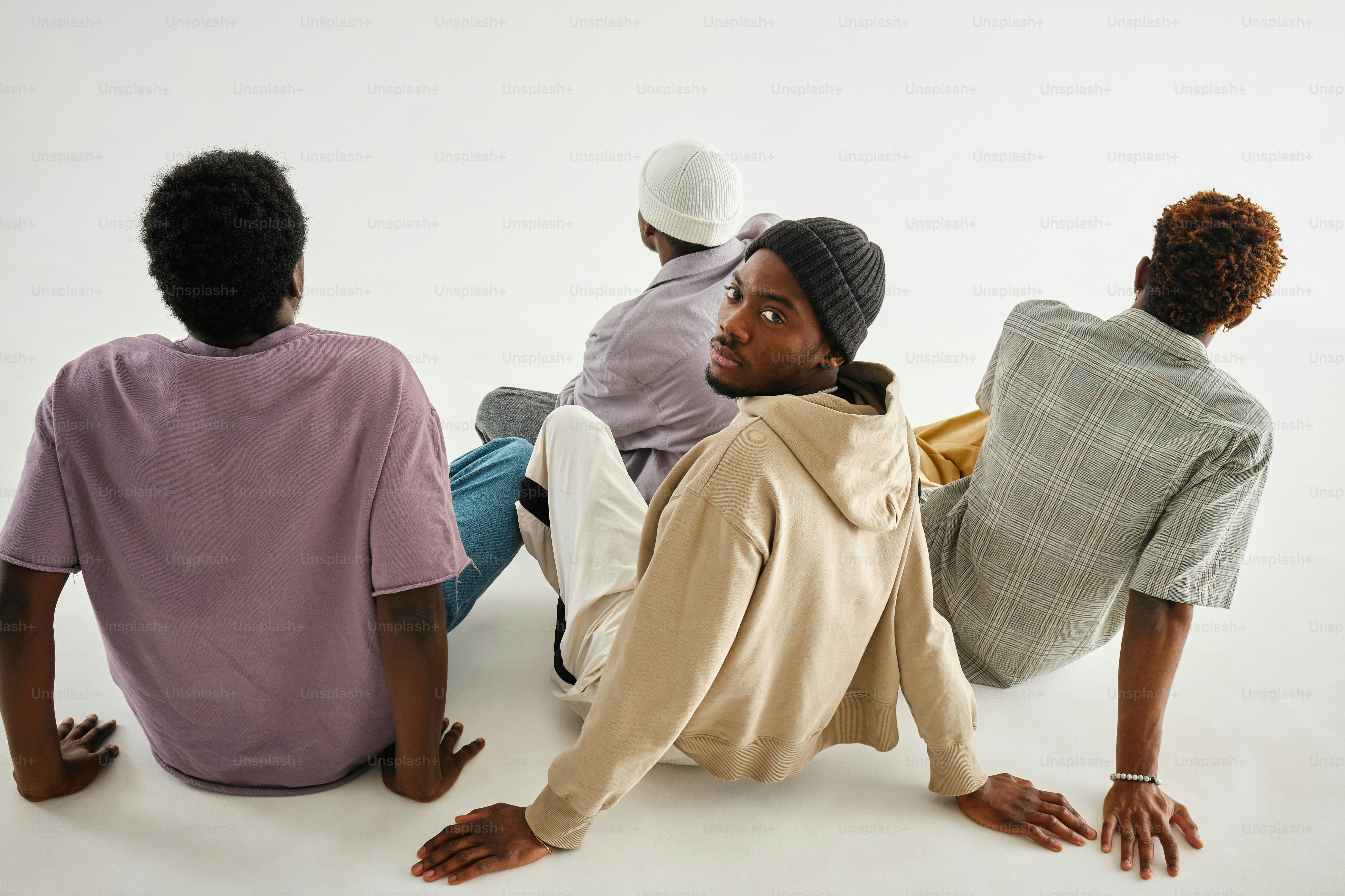 A group of three people sitting next to each other photo – Fraternity ...