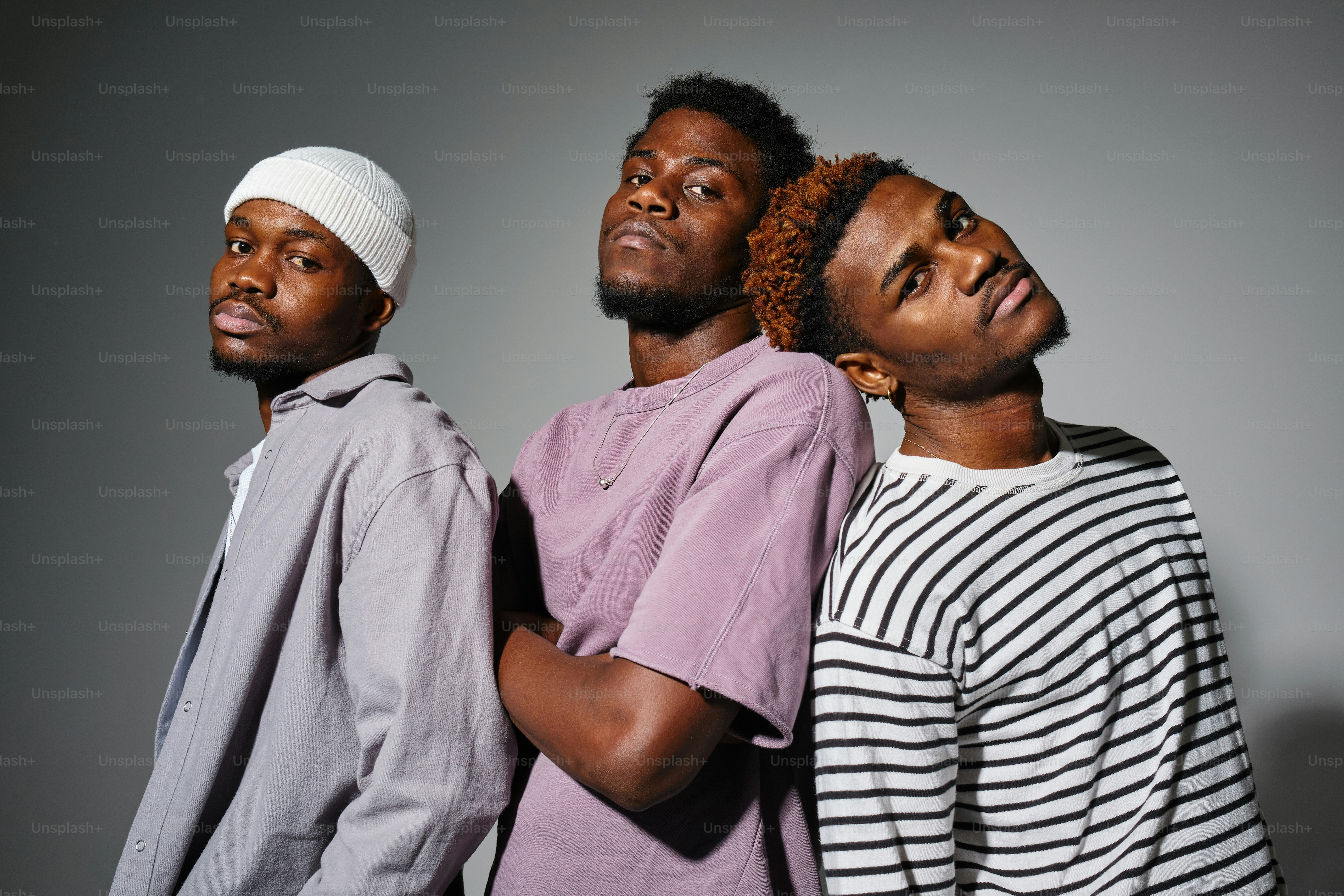 A group of three men standing next to each other photo – Group of men ...