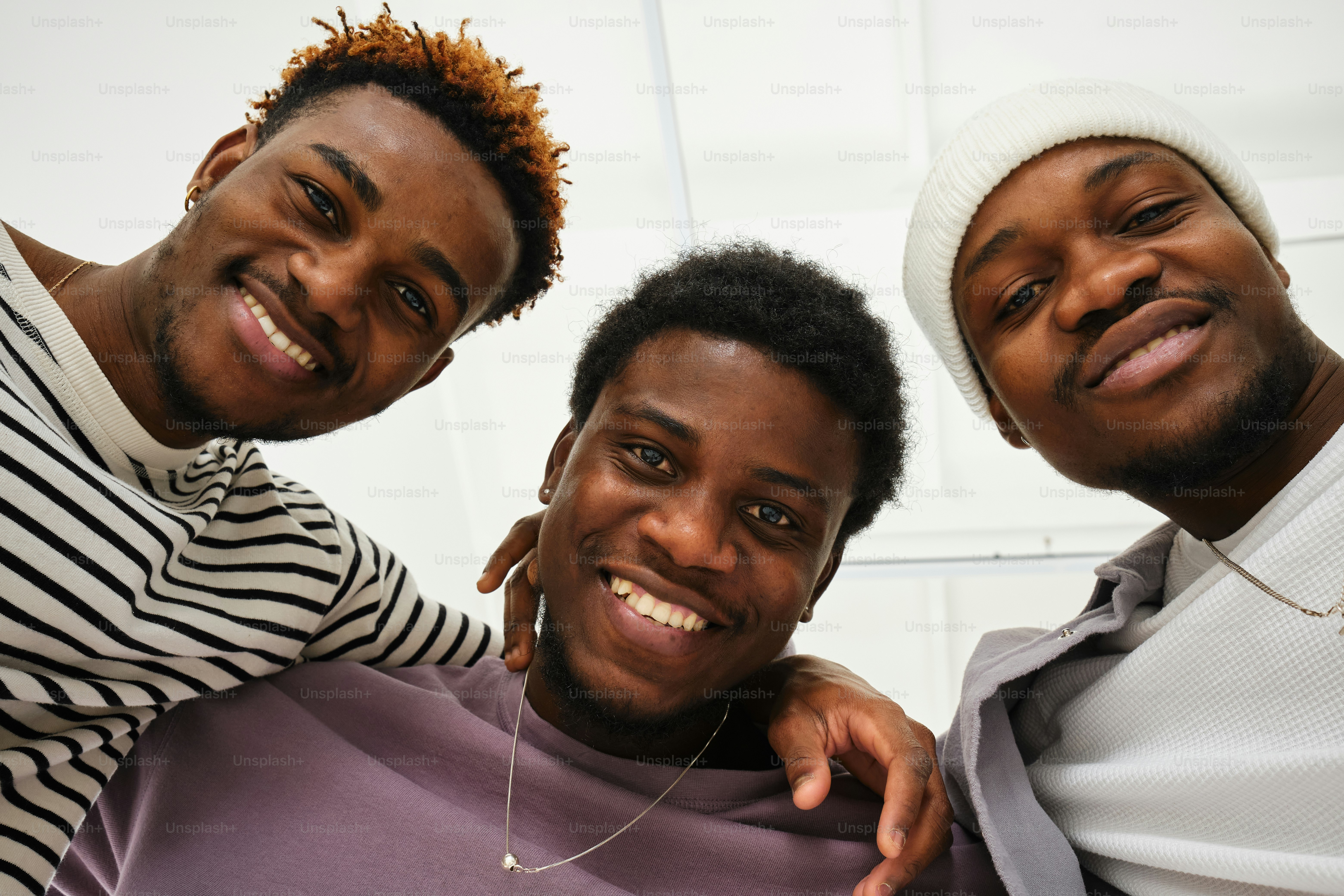 A group of three men standing next to each other photo – Group of men ...