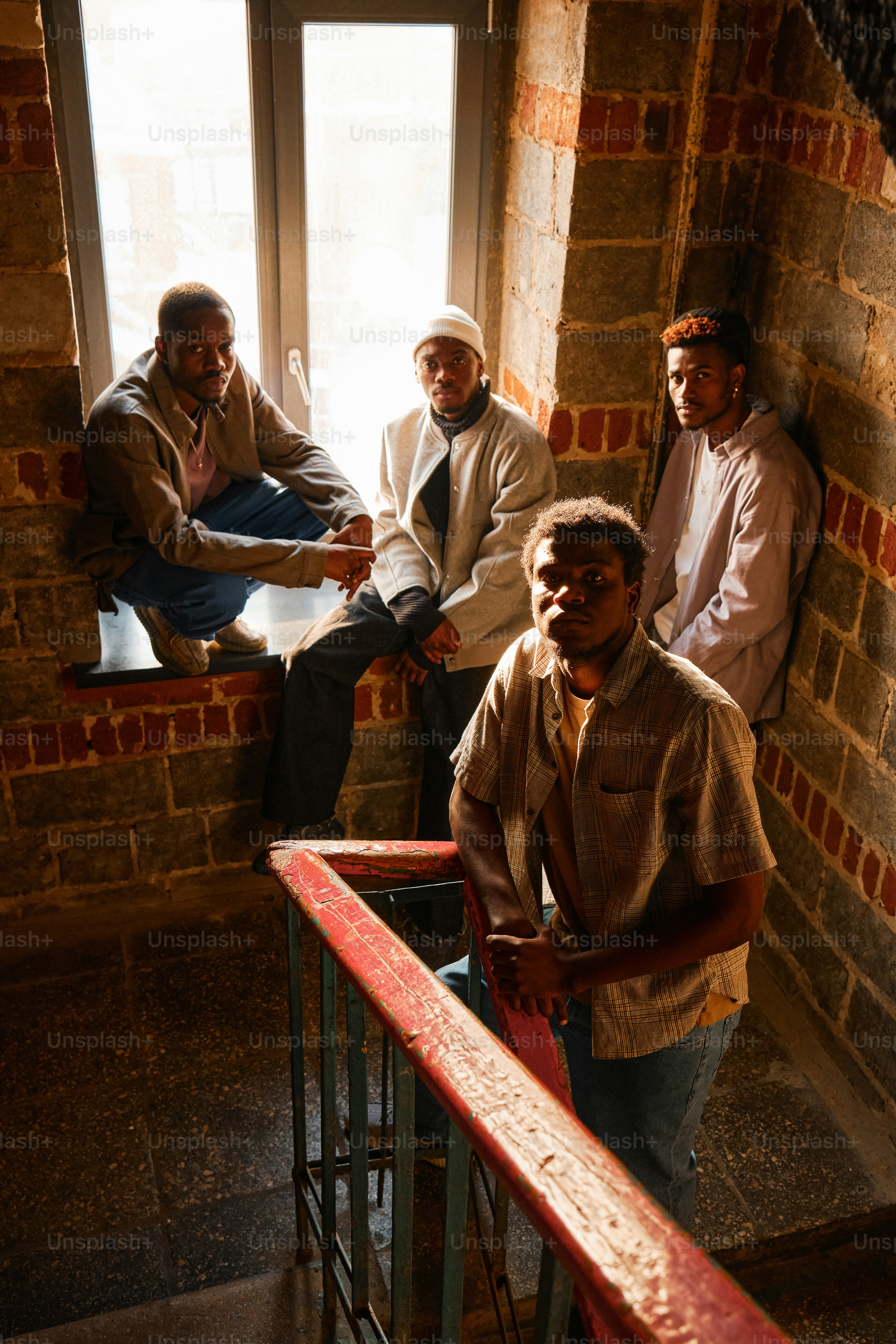 A group of three men standing next to each other photo – Group of men ...