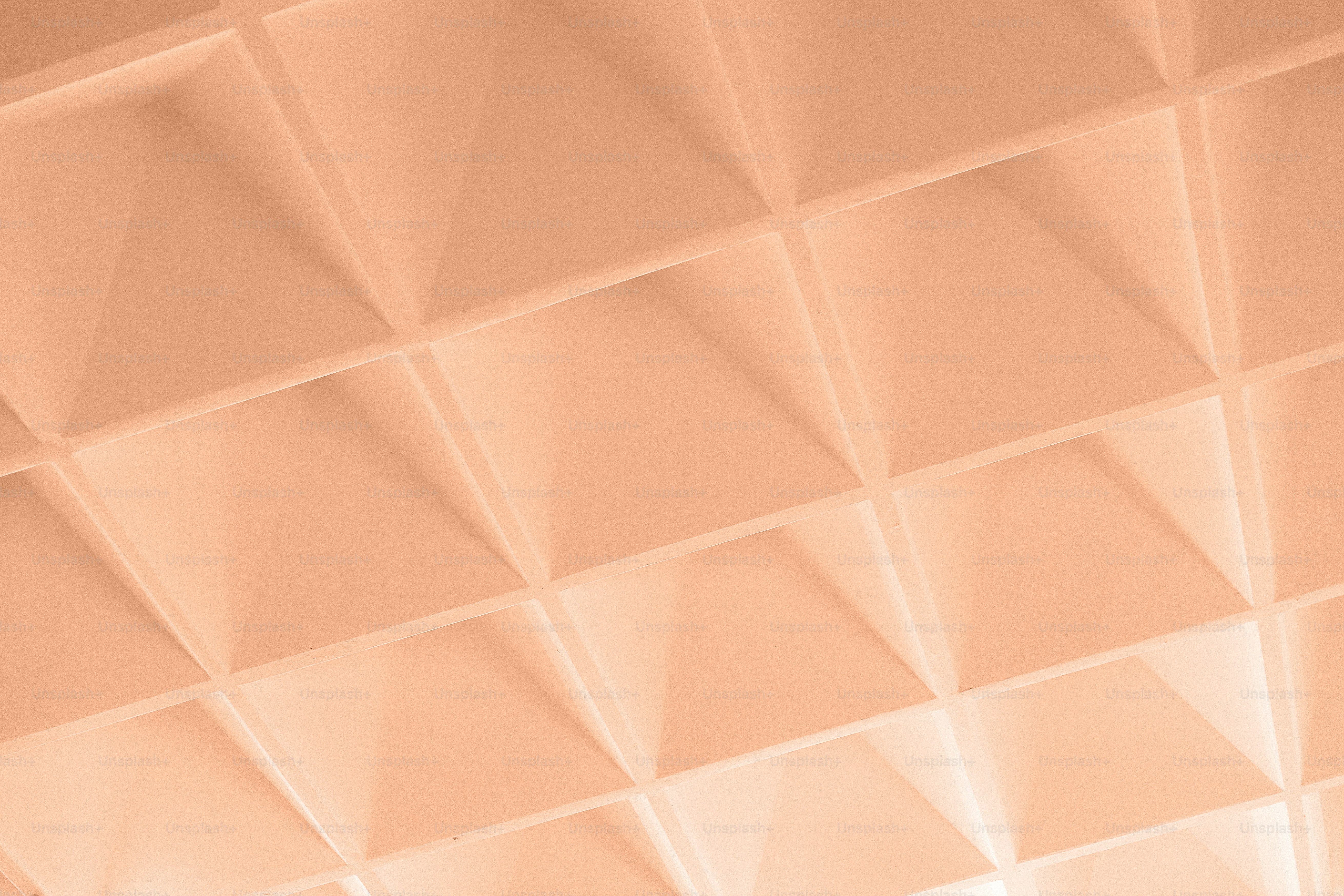 A close up of a ceiling with a light colored pattern photo – Peach pink ...