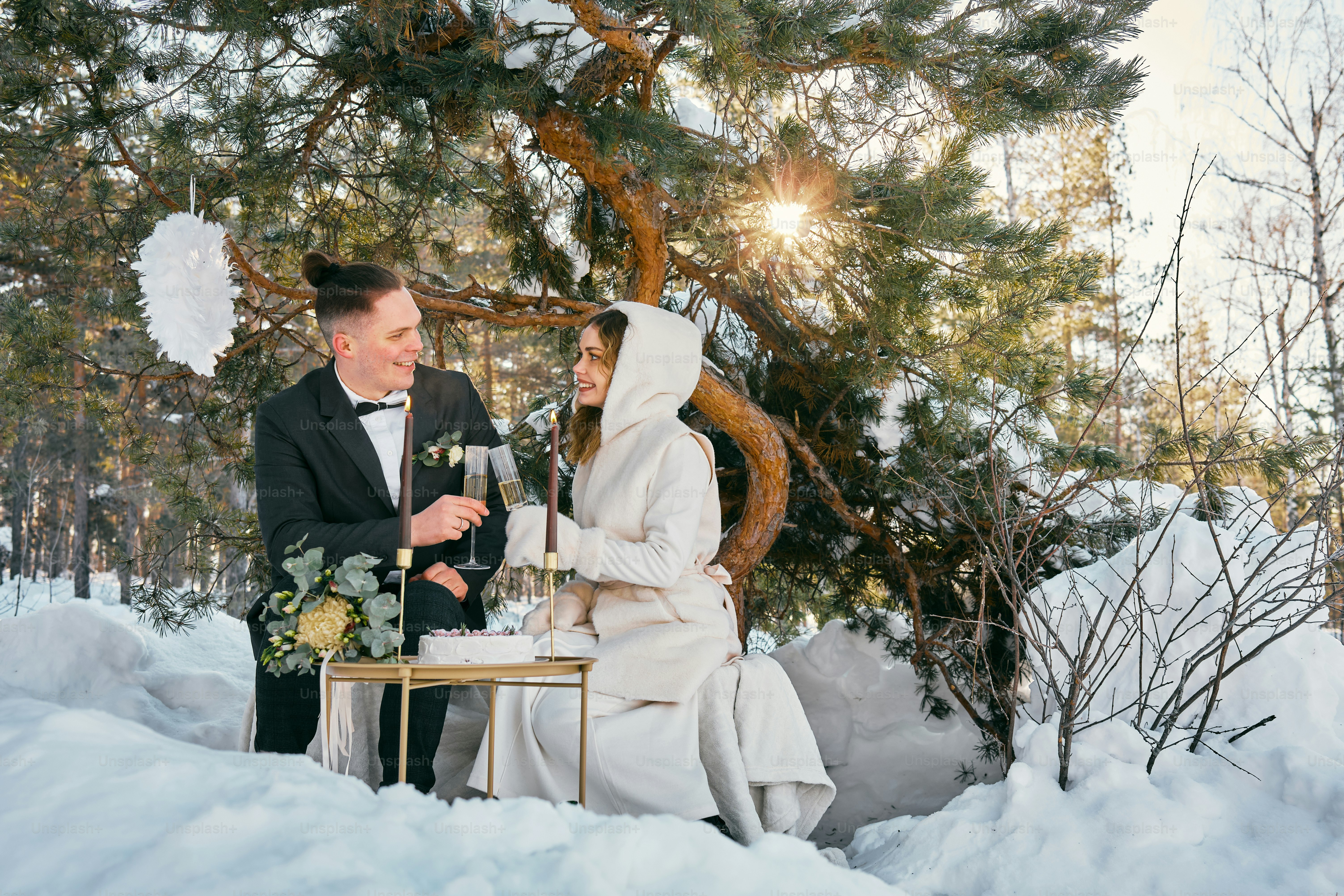 A bride and groom having a toast in the snow photo – Bride Image on ...