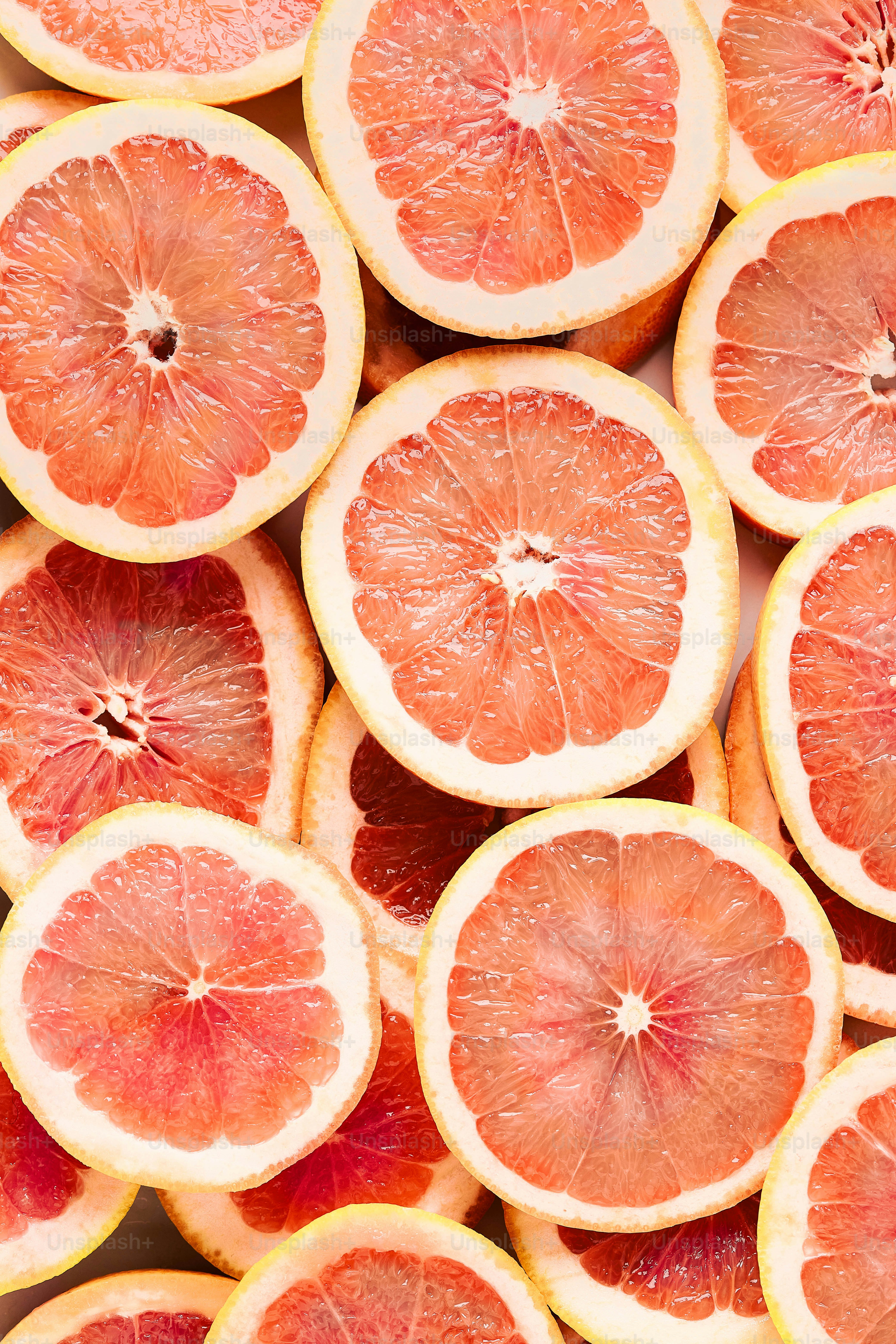 A bunch of grapefruit cut in half photo – Grapefruit slices Image on ...