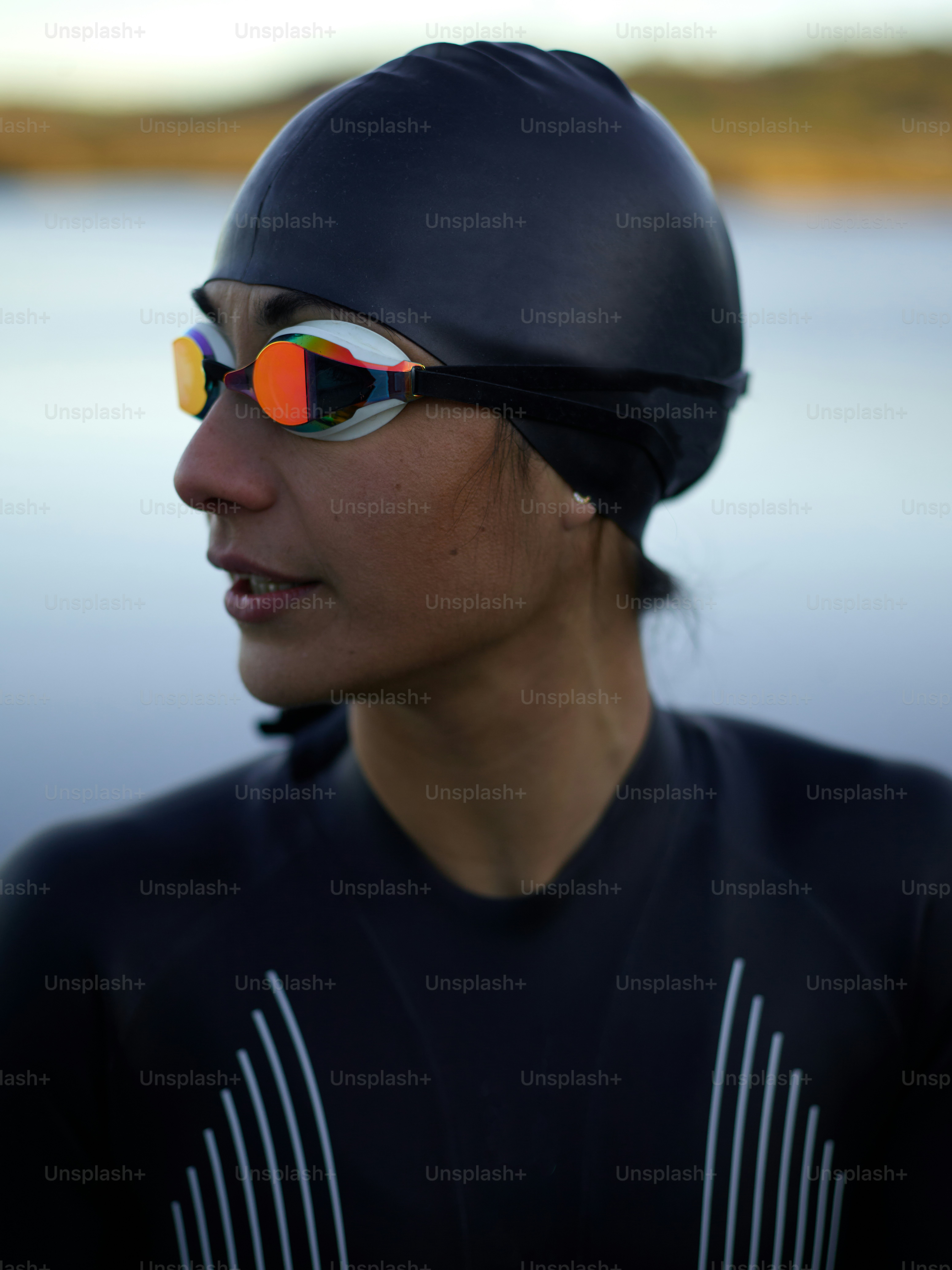 A woman wearing a helmet and swimming goggles photo – Open swim Image ...