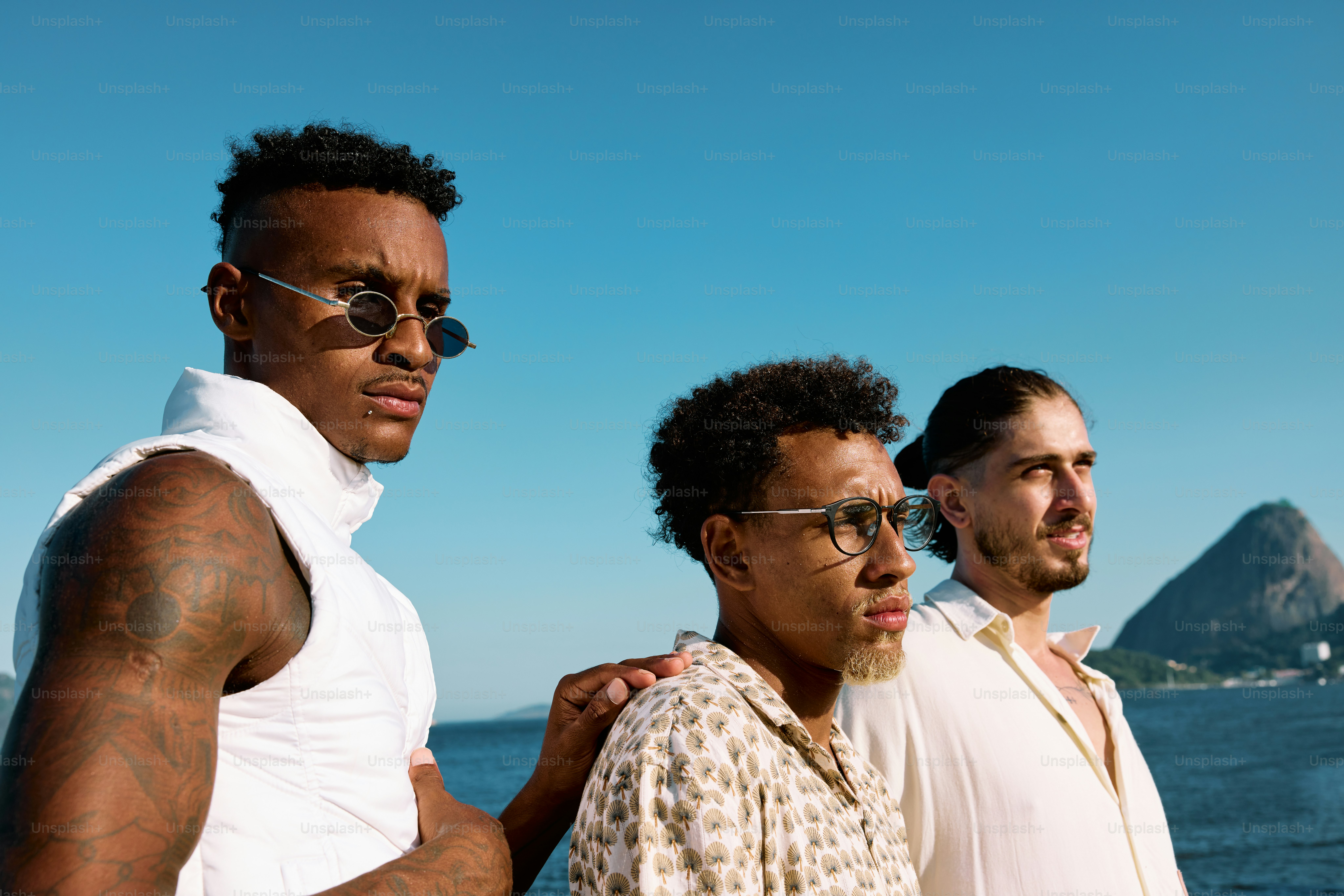 A group of three men standing next to each other photo – Group of men ...