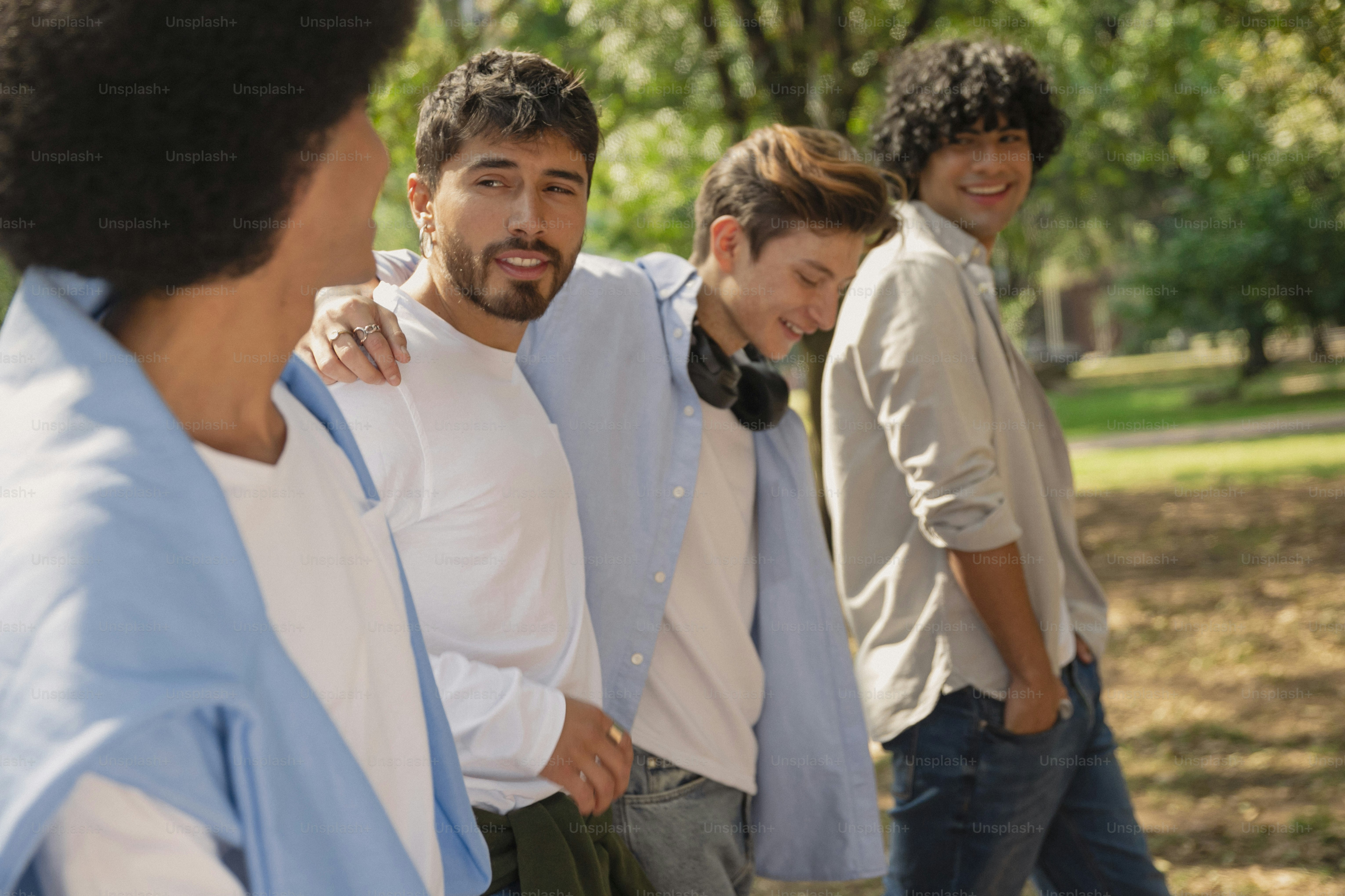 A group of young men standing next to each other photo – Happy Image on ...