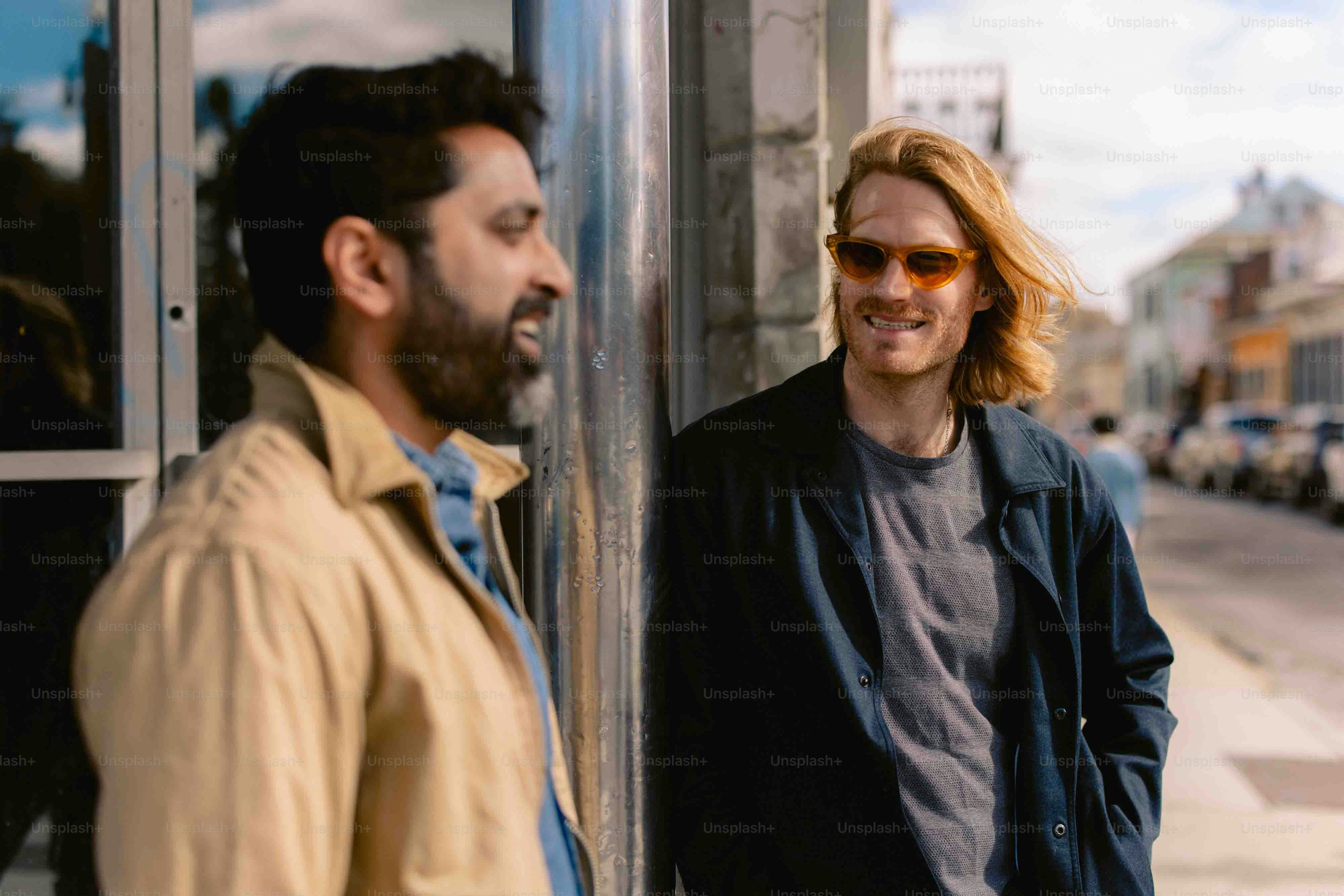 A couple of men standing next to each other photo – Friends Image on ...