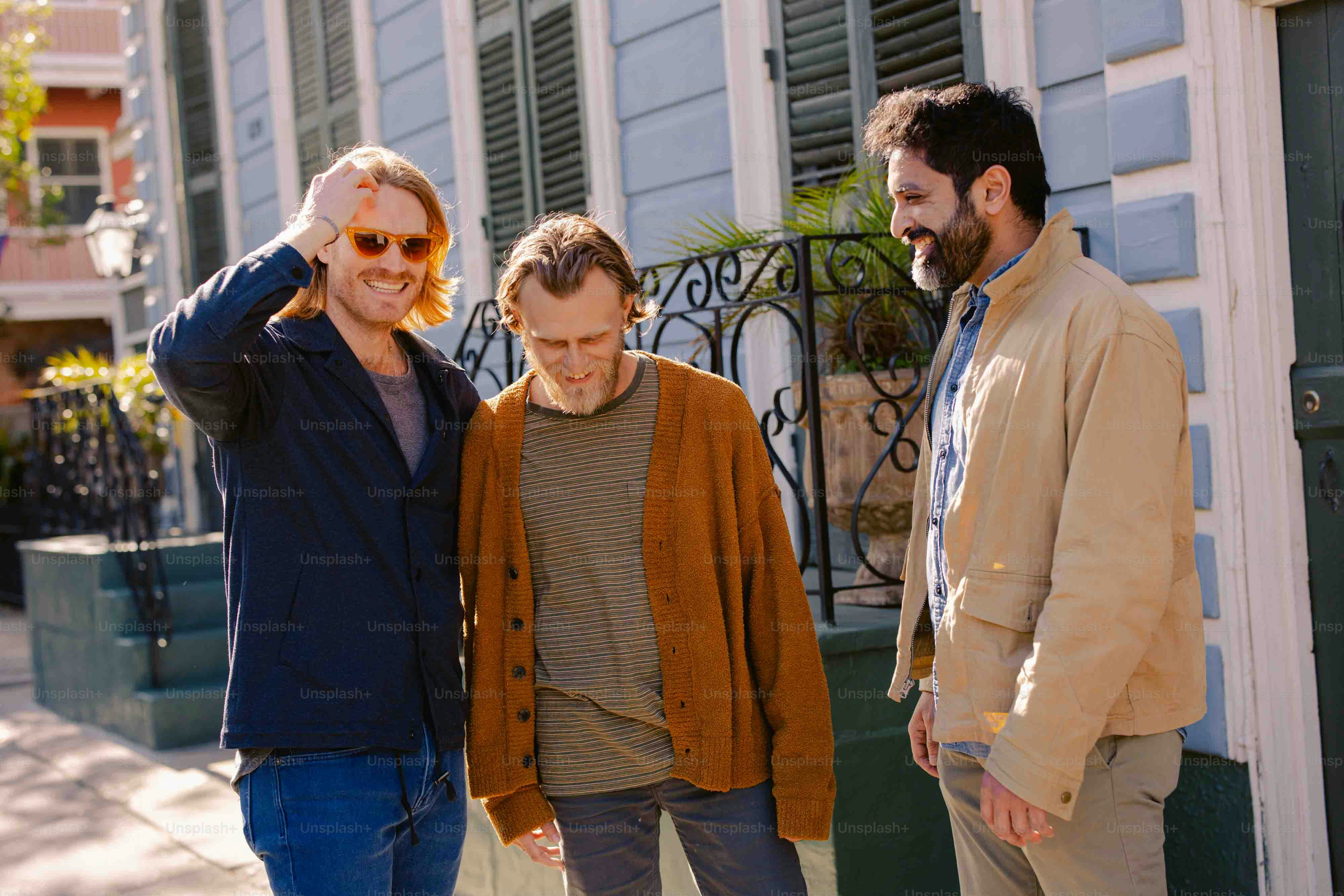 A group of three men standing next to each other photo – Friends Image ...