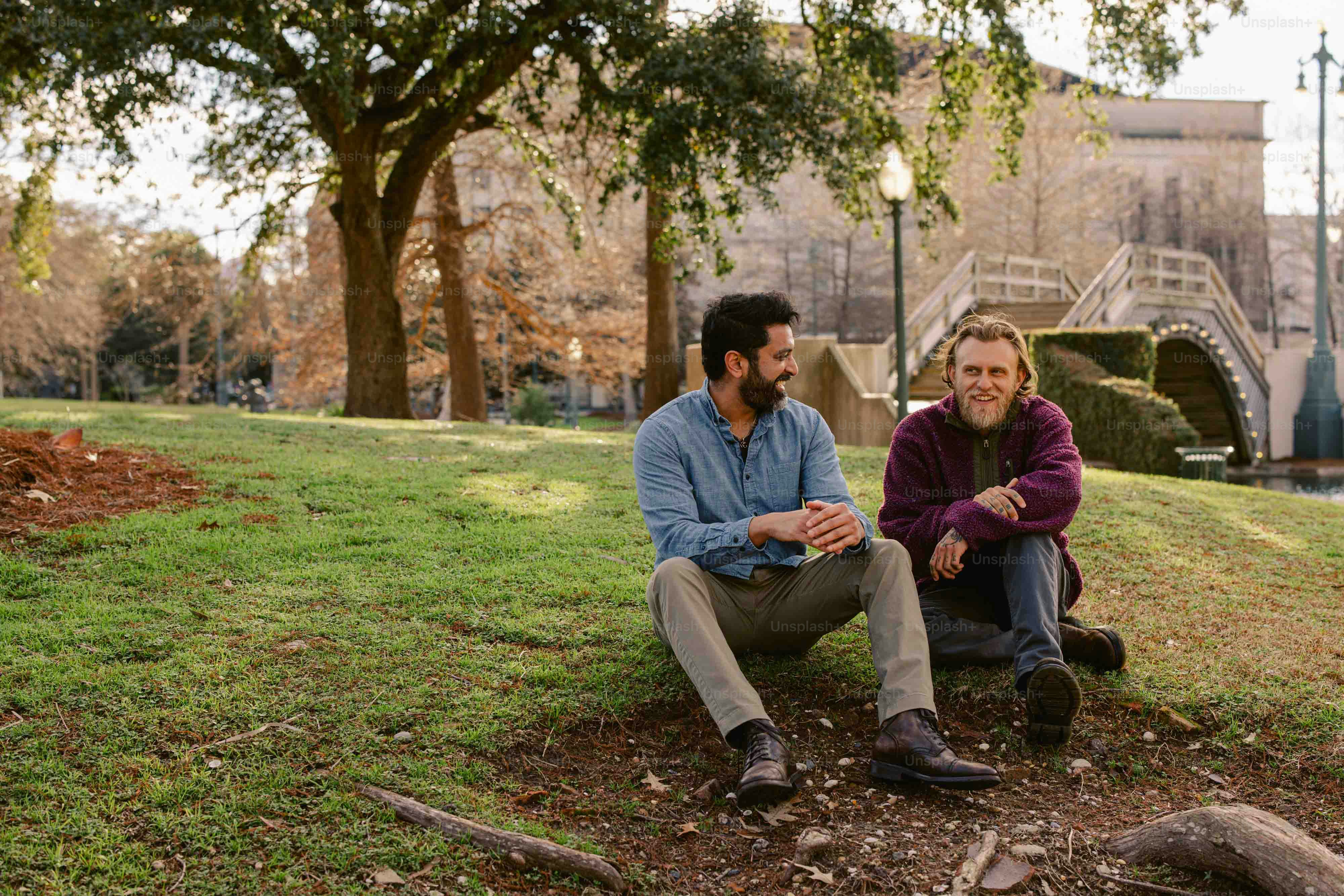Two men sitting on the ground in a park photo – Friends Image on Unsplash