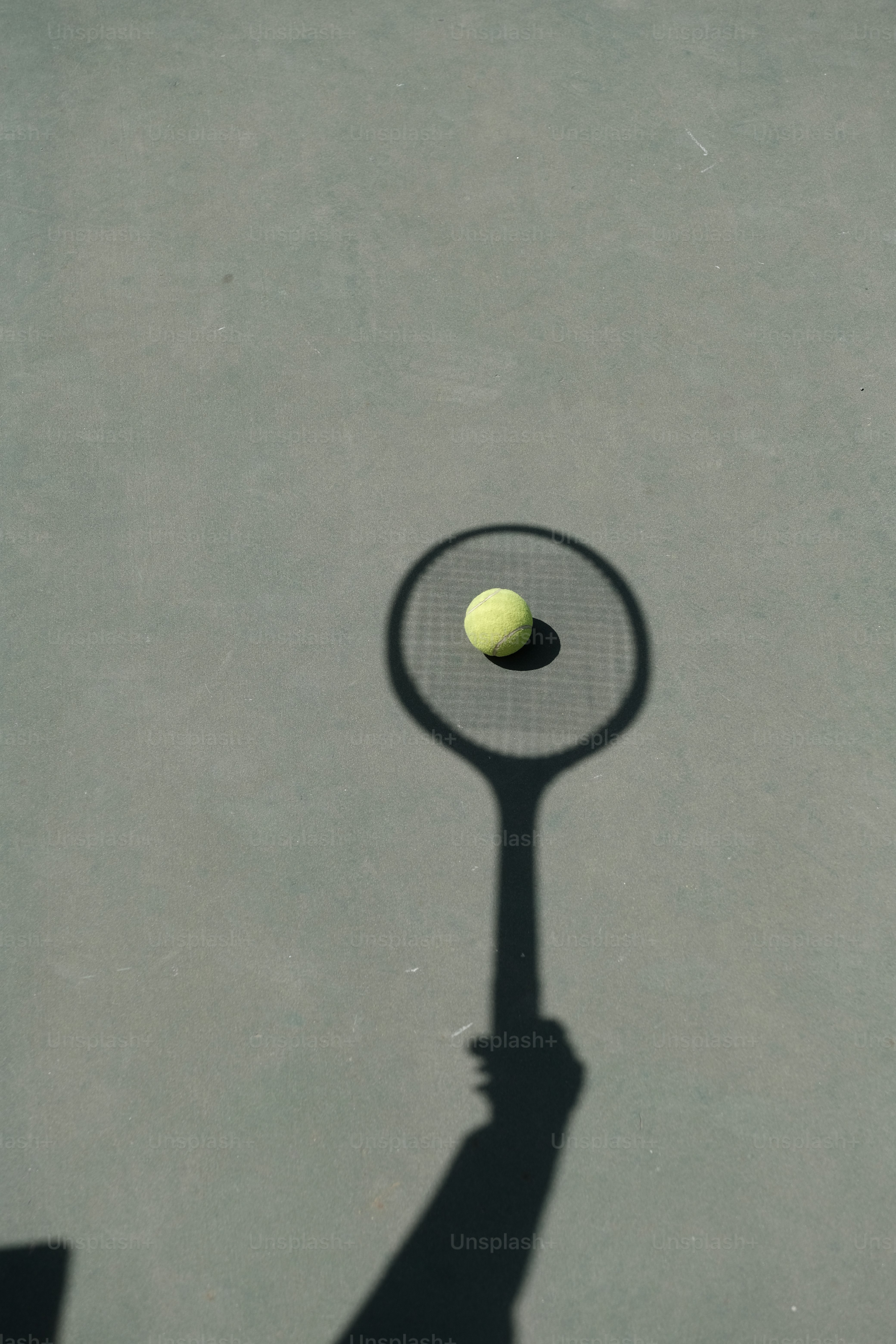A shadow of a person holding a tennis racket and a tennis ball photo ...