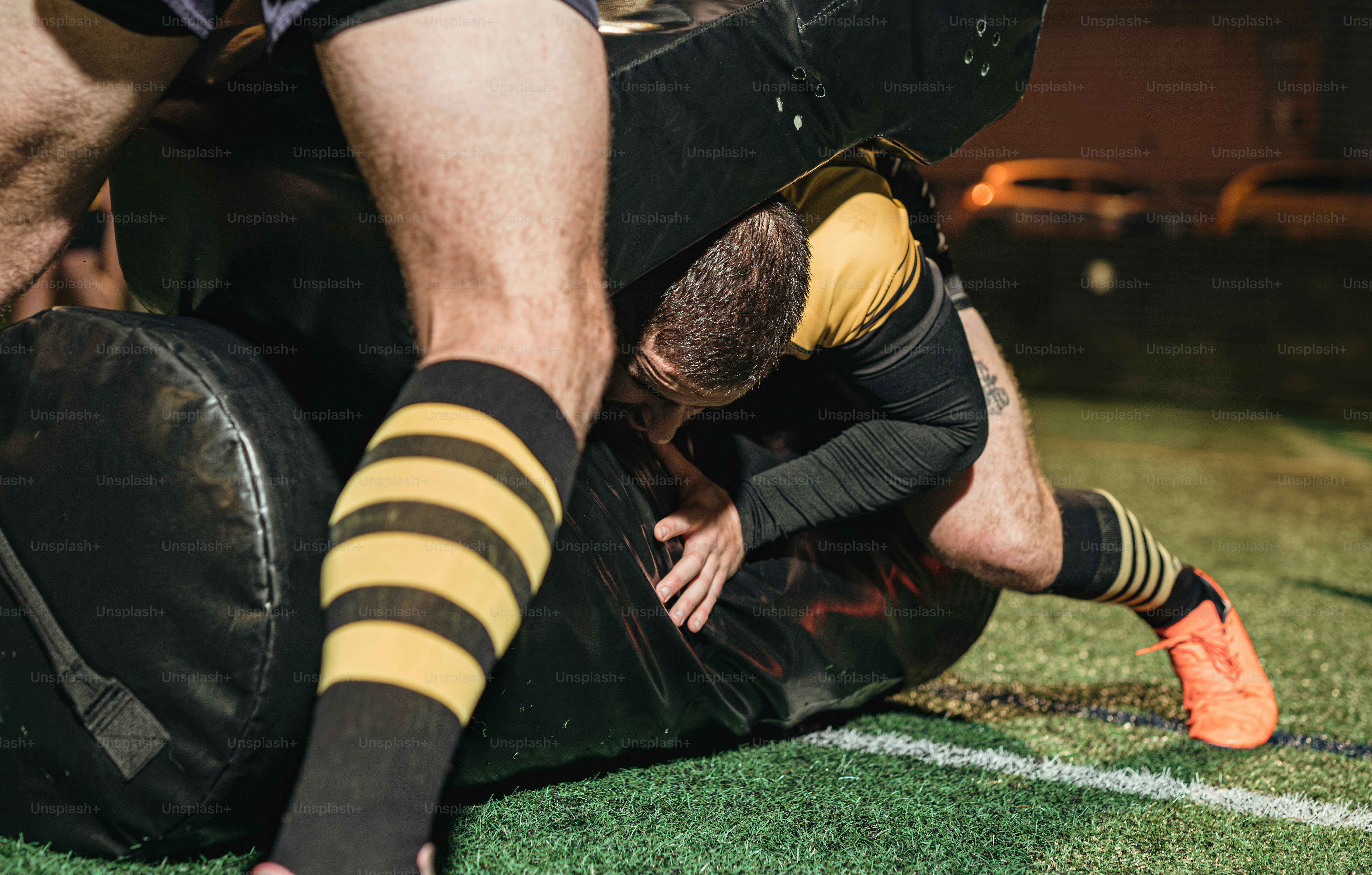 A soccer player is on the ground with his leg on the ground photo ...