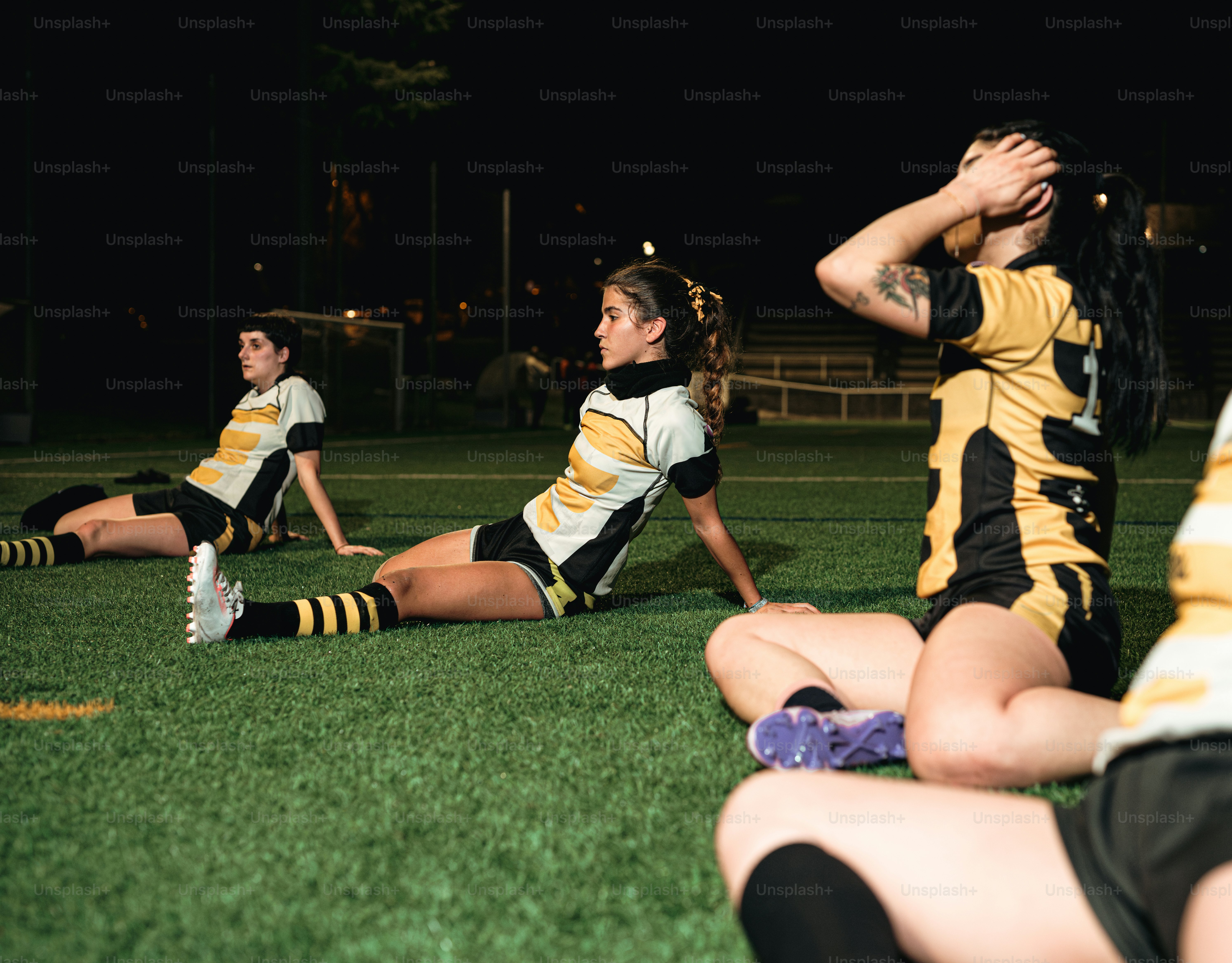 A group of people standing on top of a field photo – Team Image on Unsplash