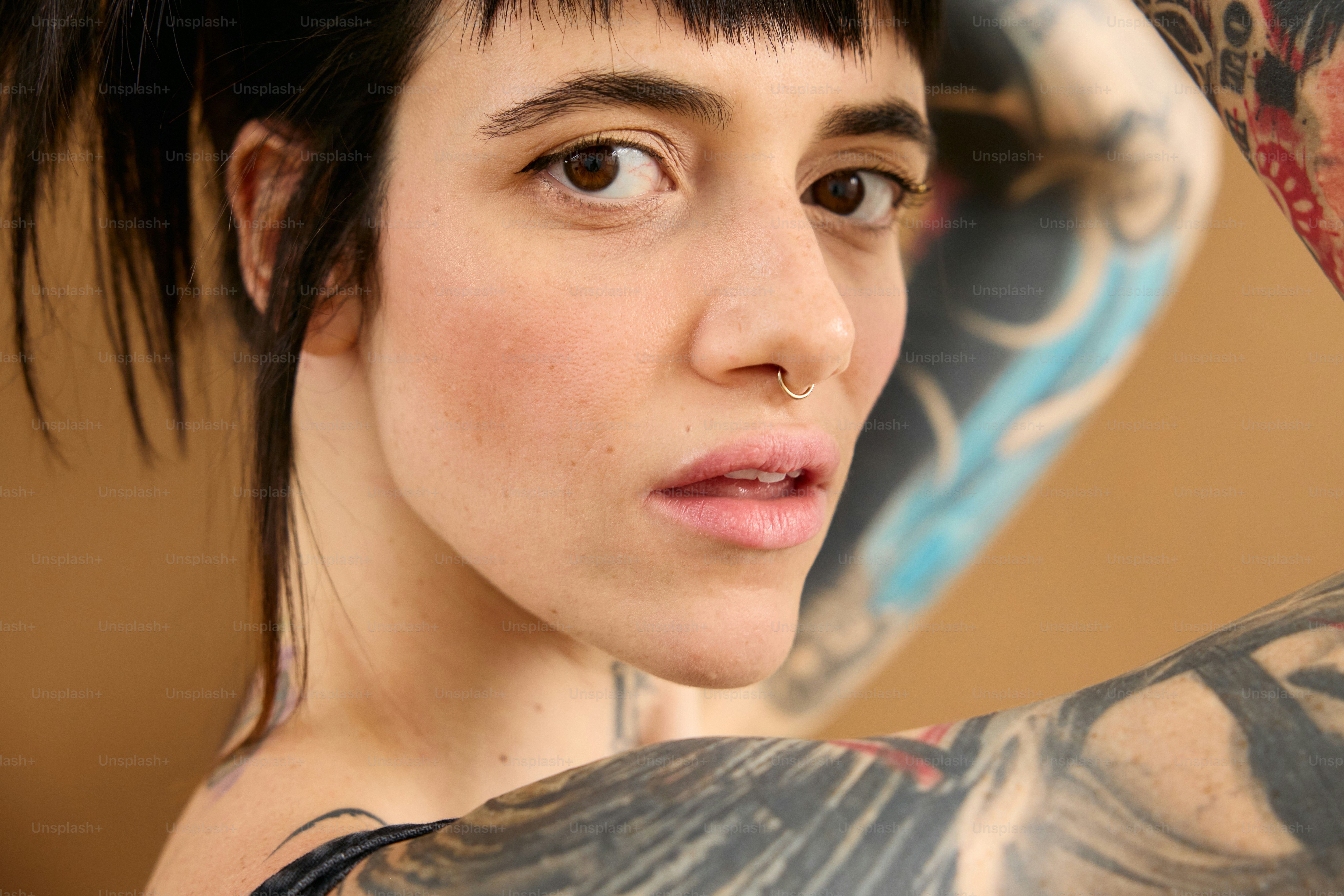 A close up of a person with tattoos on their arms photo – Tattooed ...