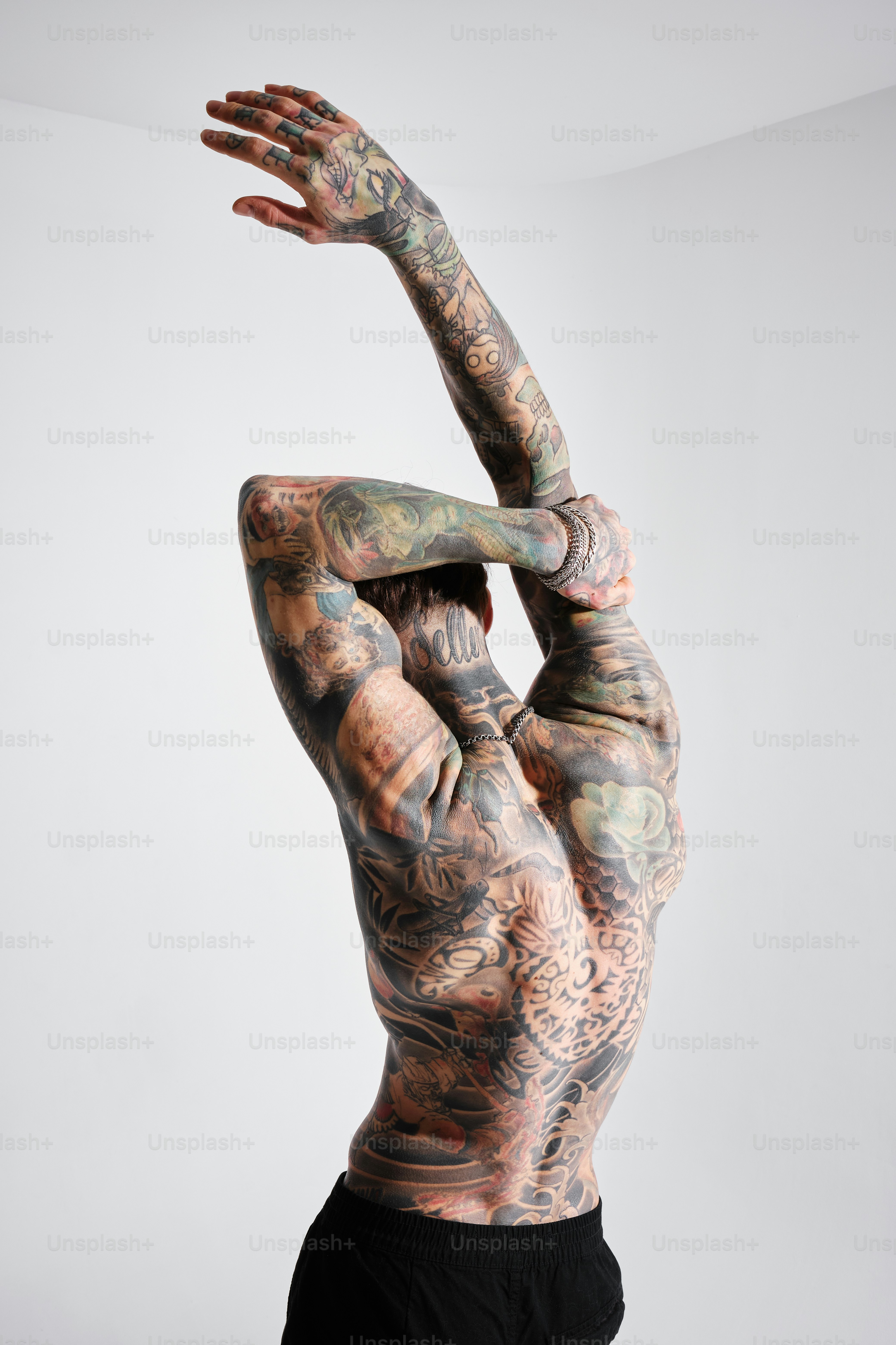 A man with a lot of tattoos on his back photo – Portrait Image on Unsplash