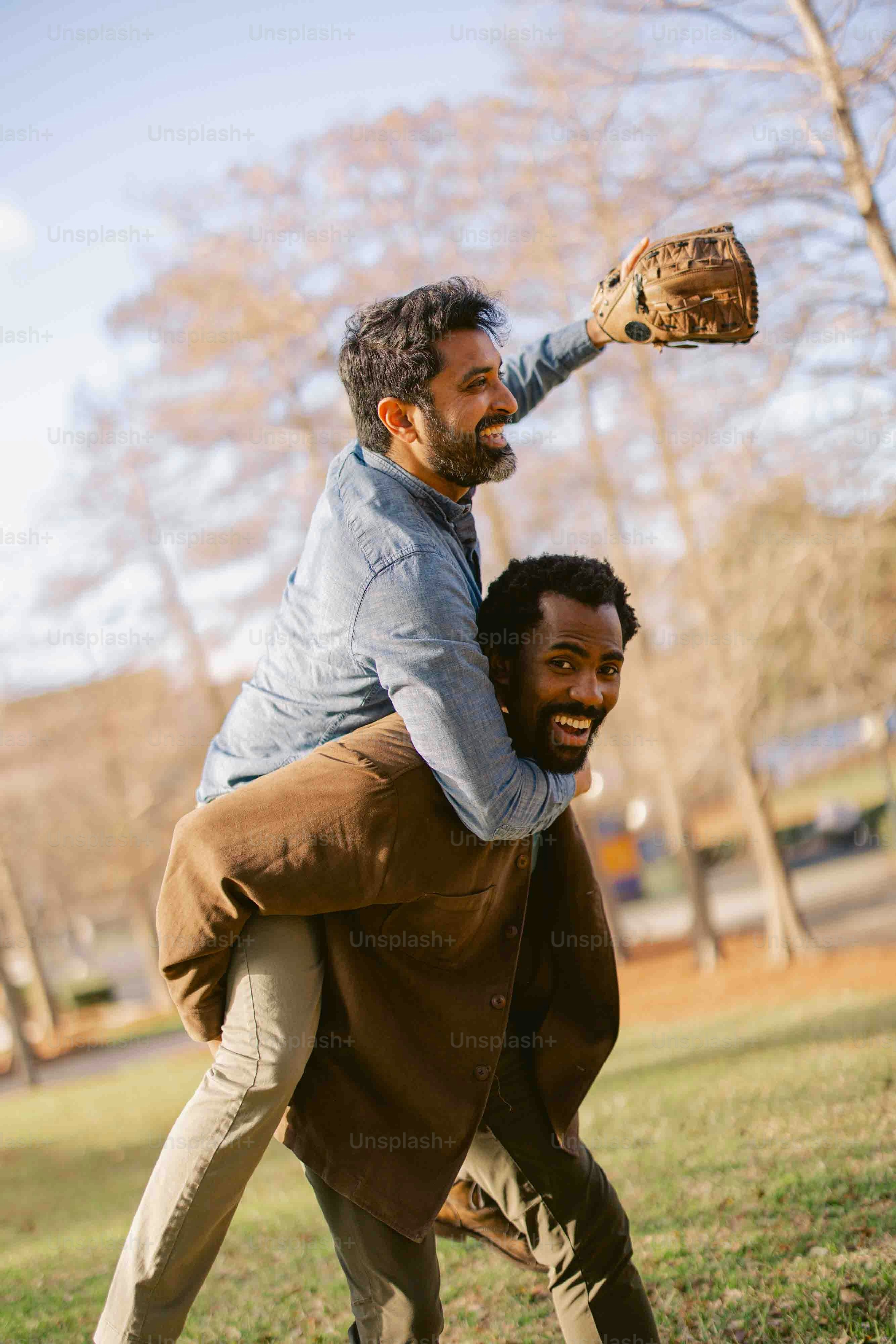 A man is lifting another man on his back photo – Mates Image on Unsplash