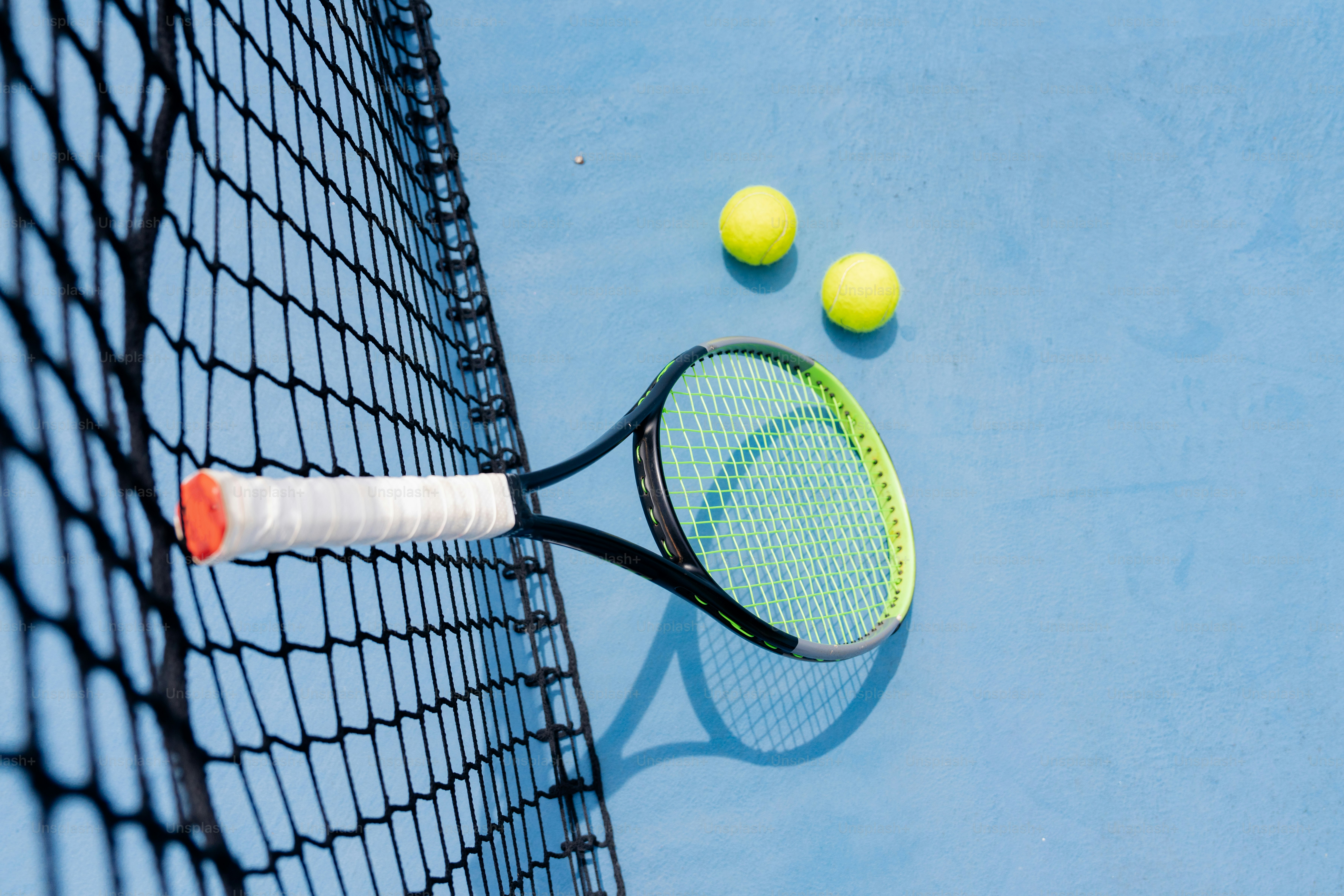 A tennis racket and three tennis balls on a tennis court photo – Sport ...