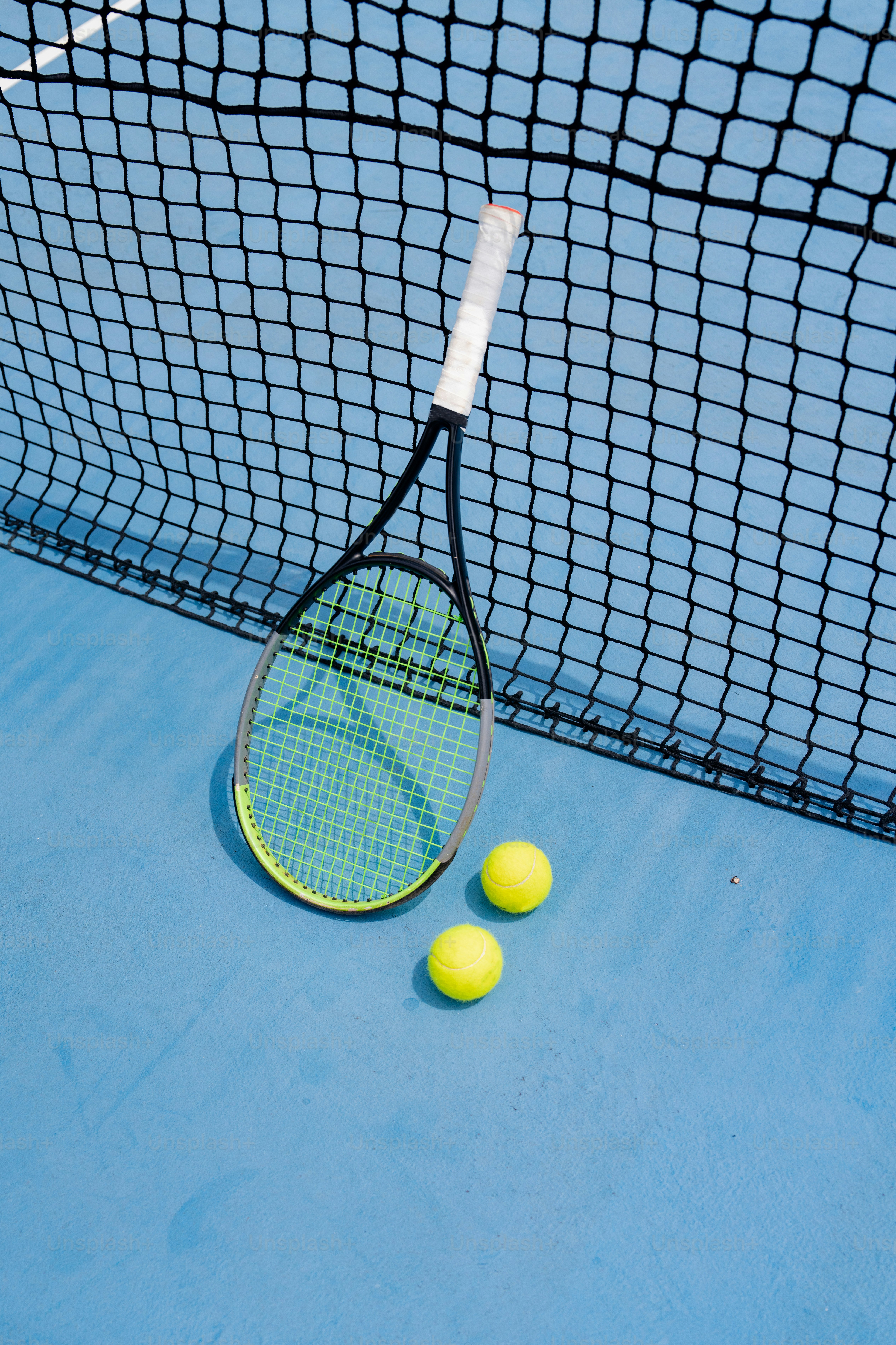 A tennis racket and three tennis balls on a tennis court photo – Sport ...