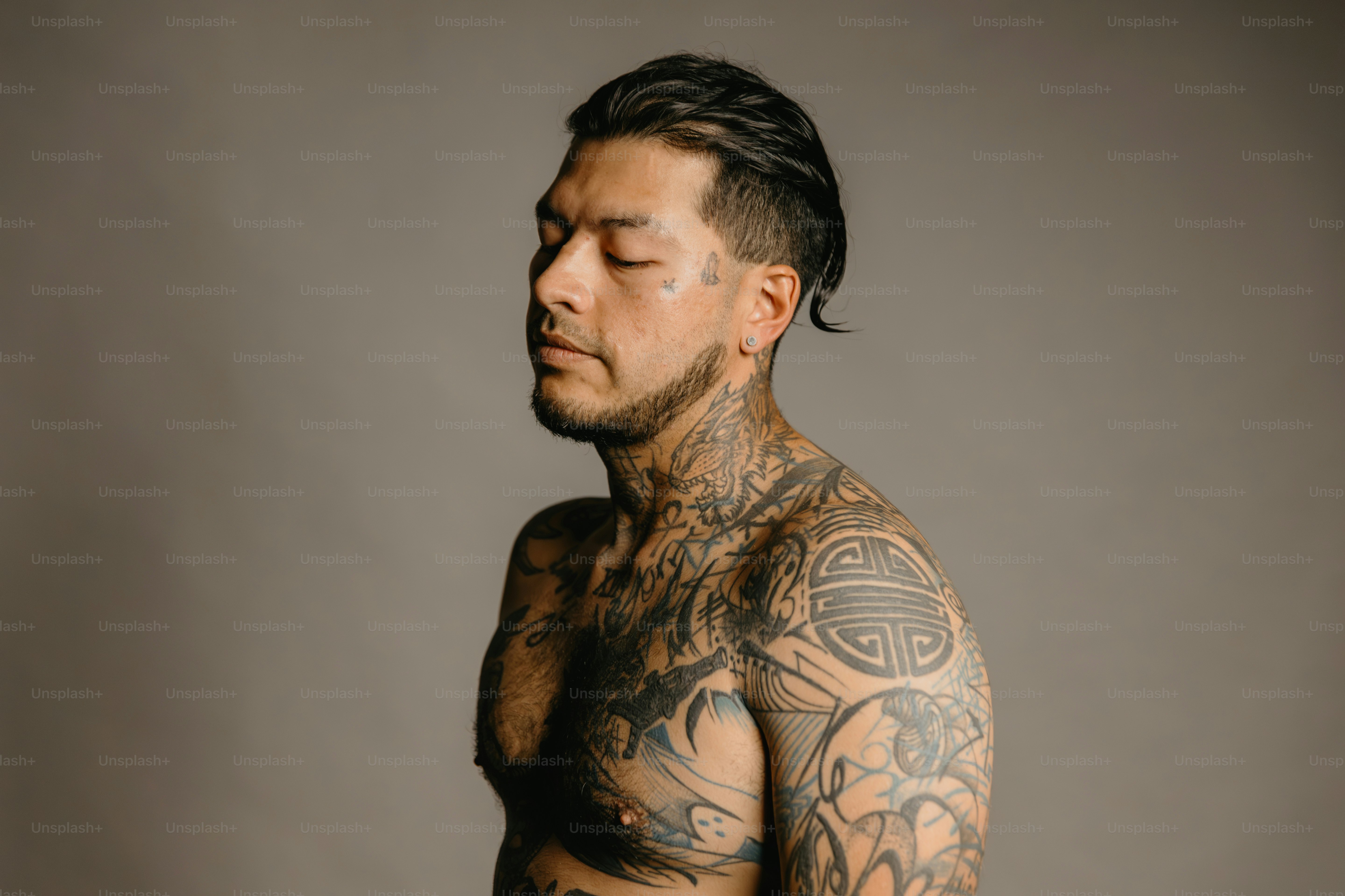A man with a lot of tattoos on his chest photo – Tattoos Image on Unsplash