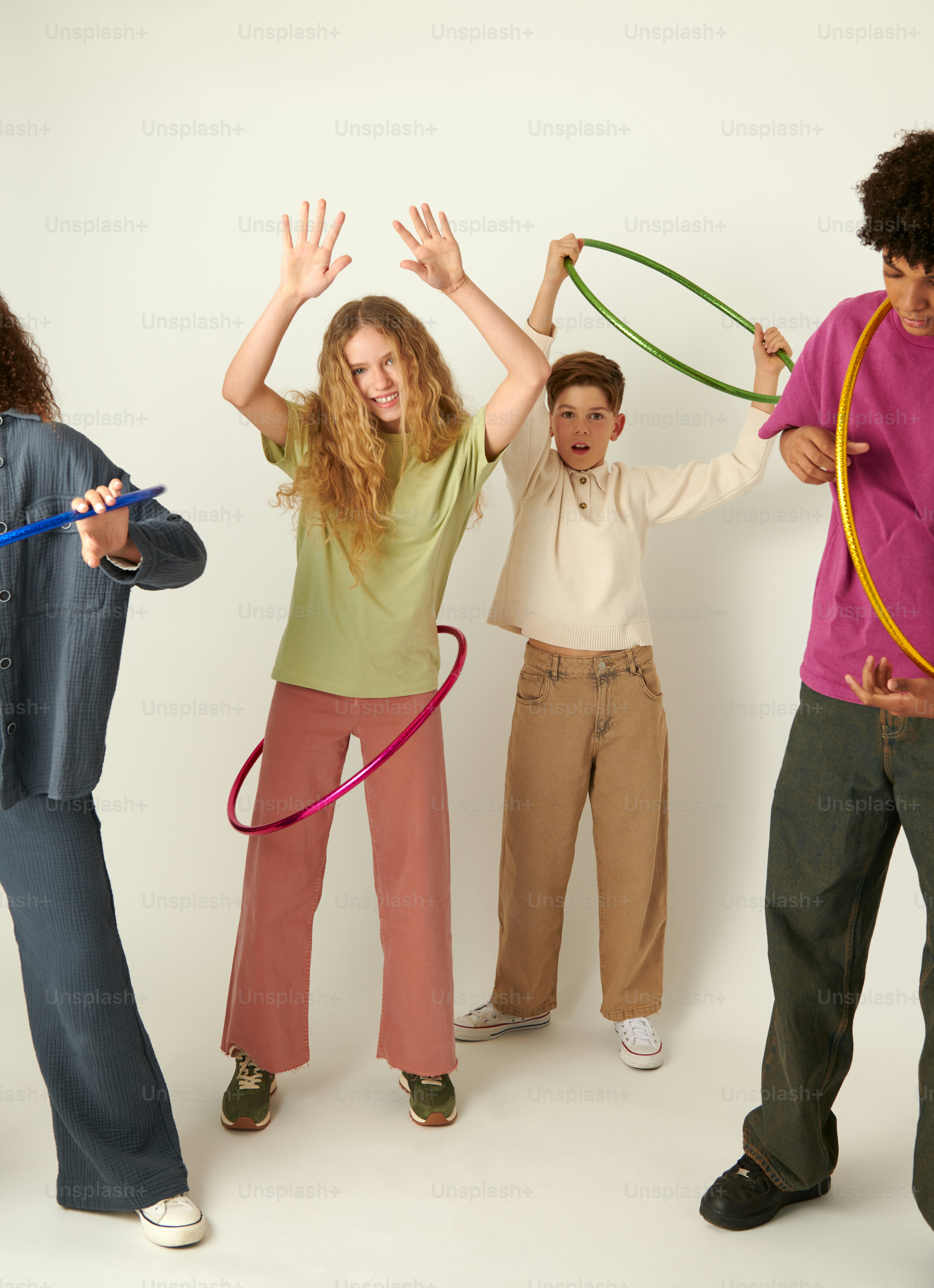 A group of people standing next to each other photo – Hula hooping ...