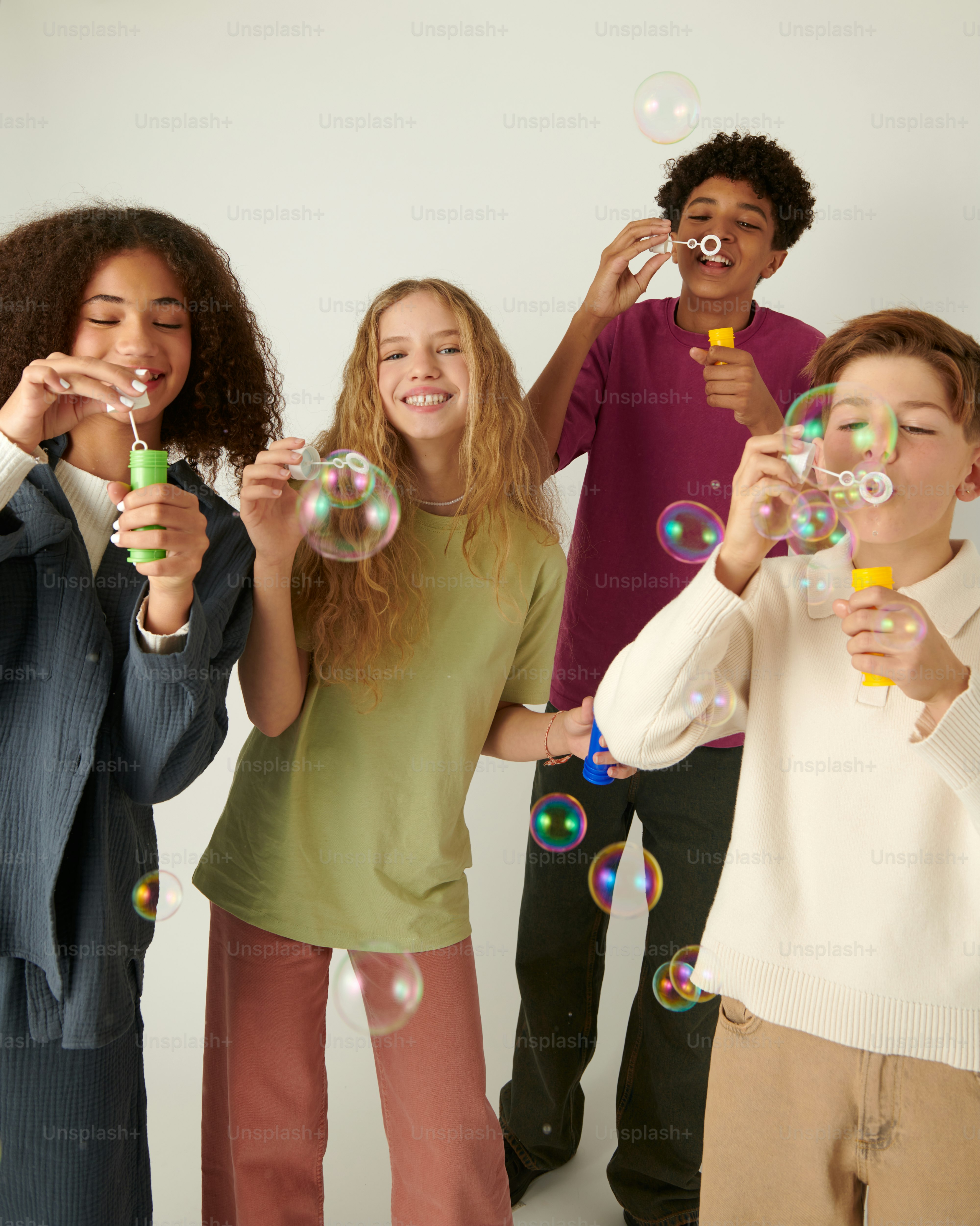 A group of people blowing bubbles in the air photo – Blowing bubbles ...