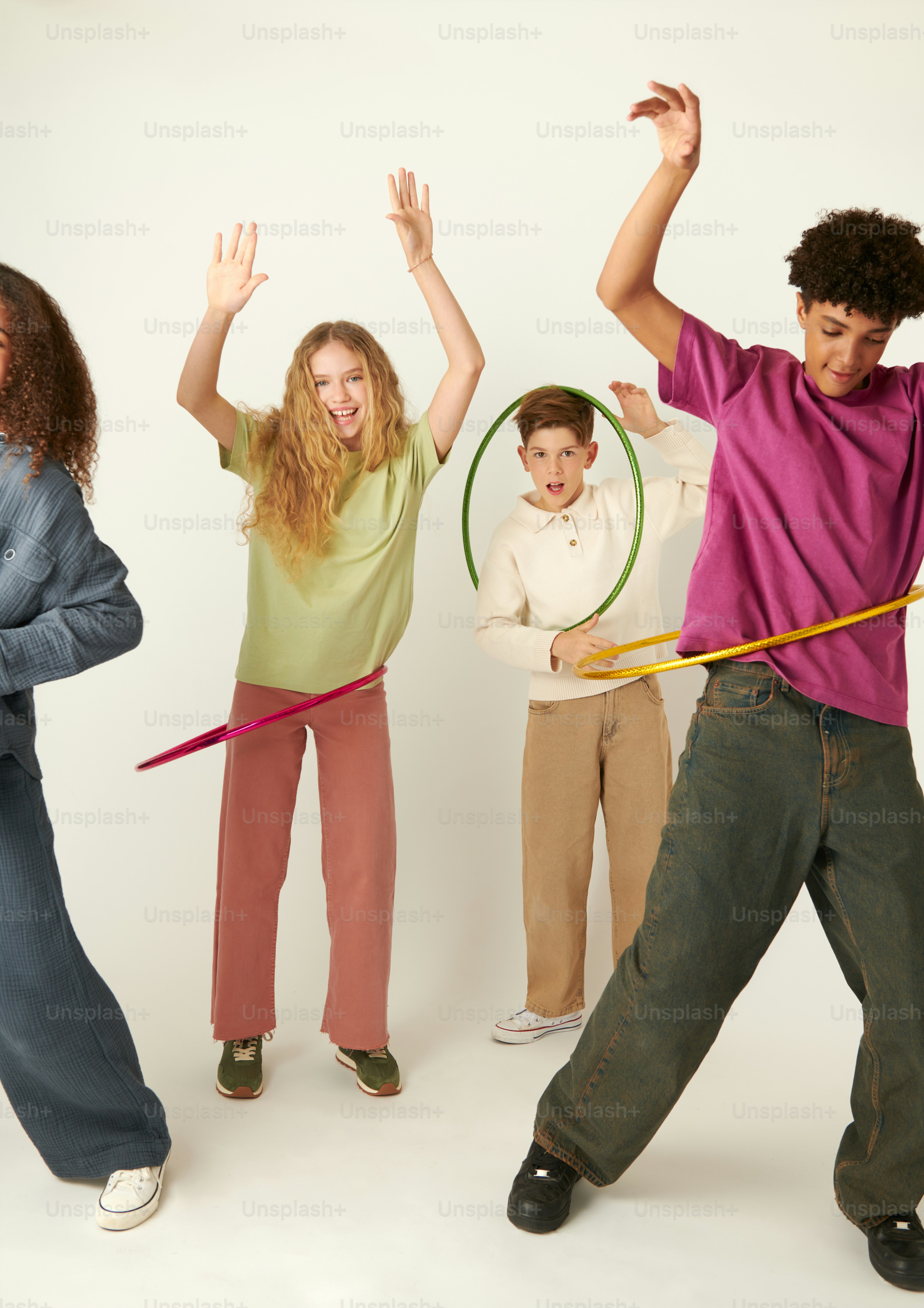 A group of people standing next to each other photo – Hula hooping ...