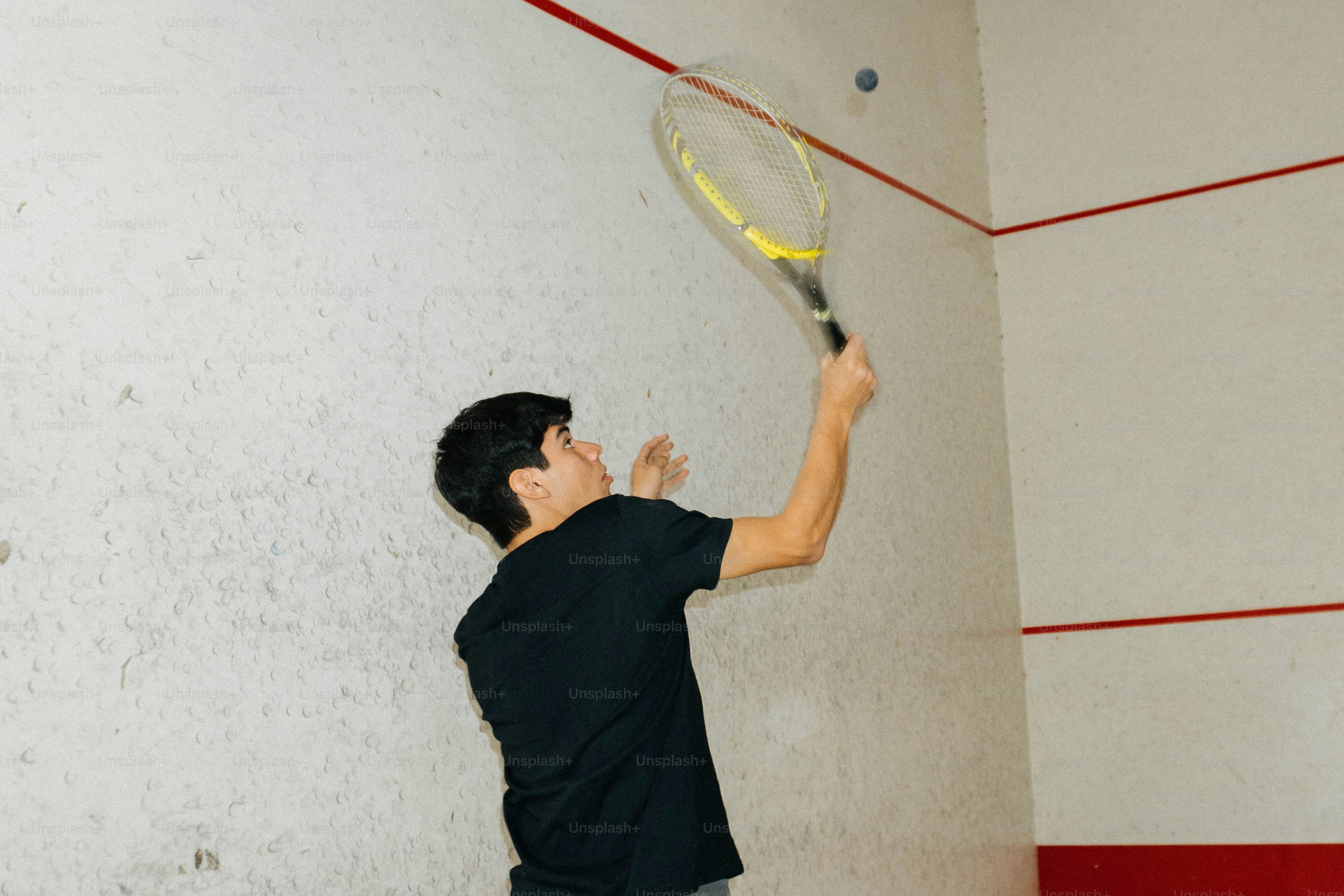 A man holding a tennis racquet up in the air photo – Racket Image on ...