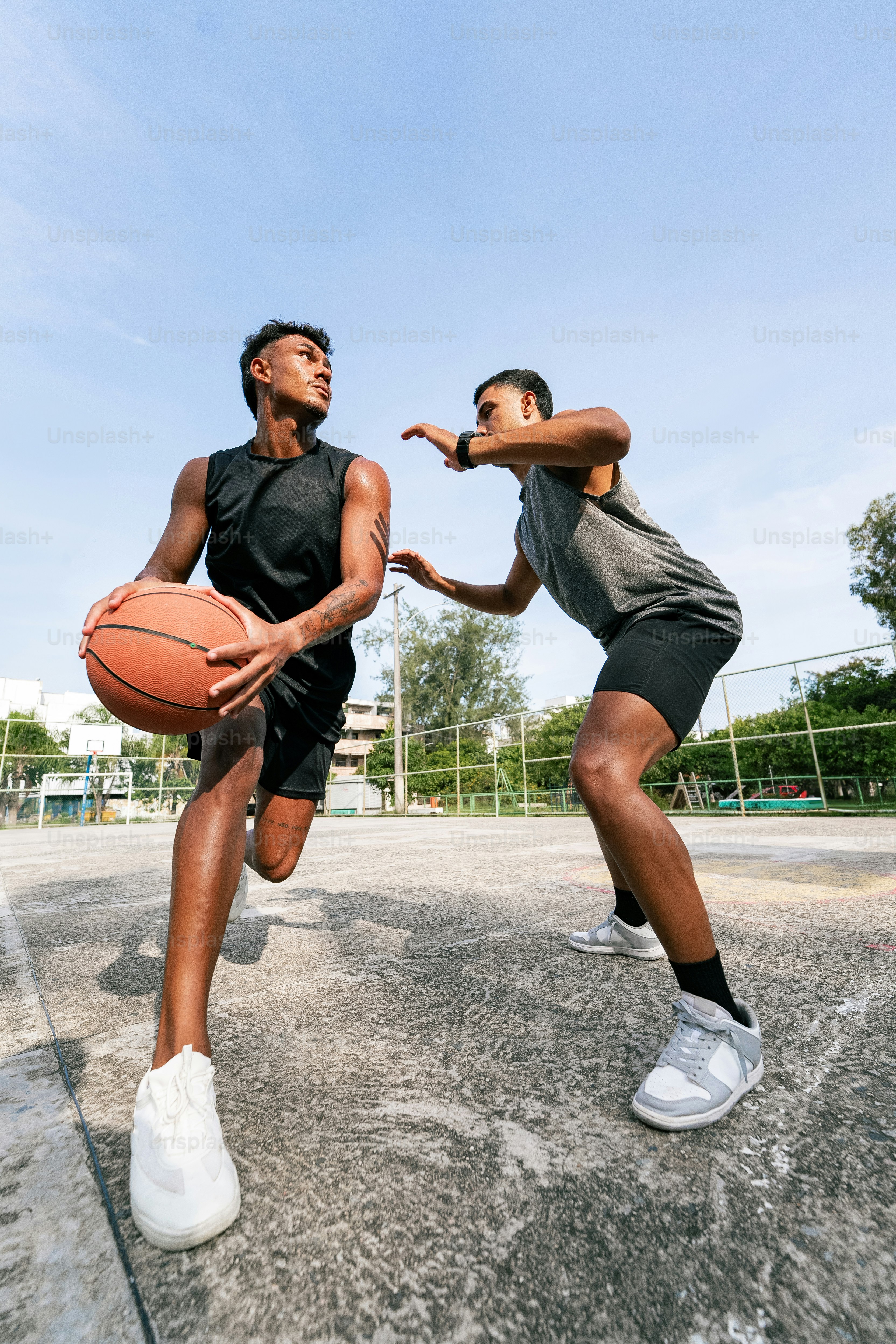 A couple of men playing a game of basketball photo – Playing basketball ...