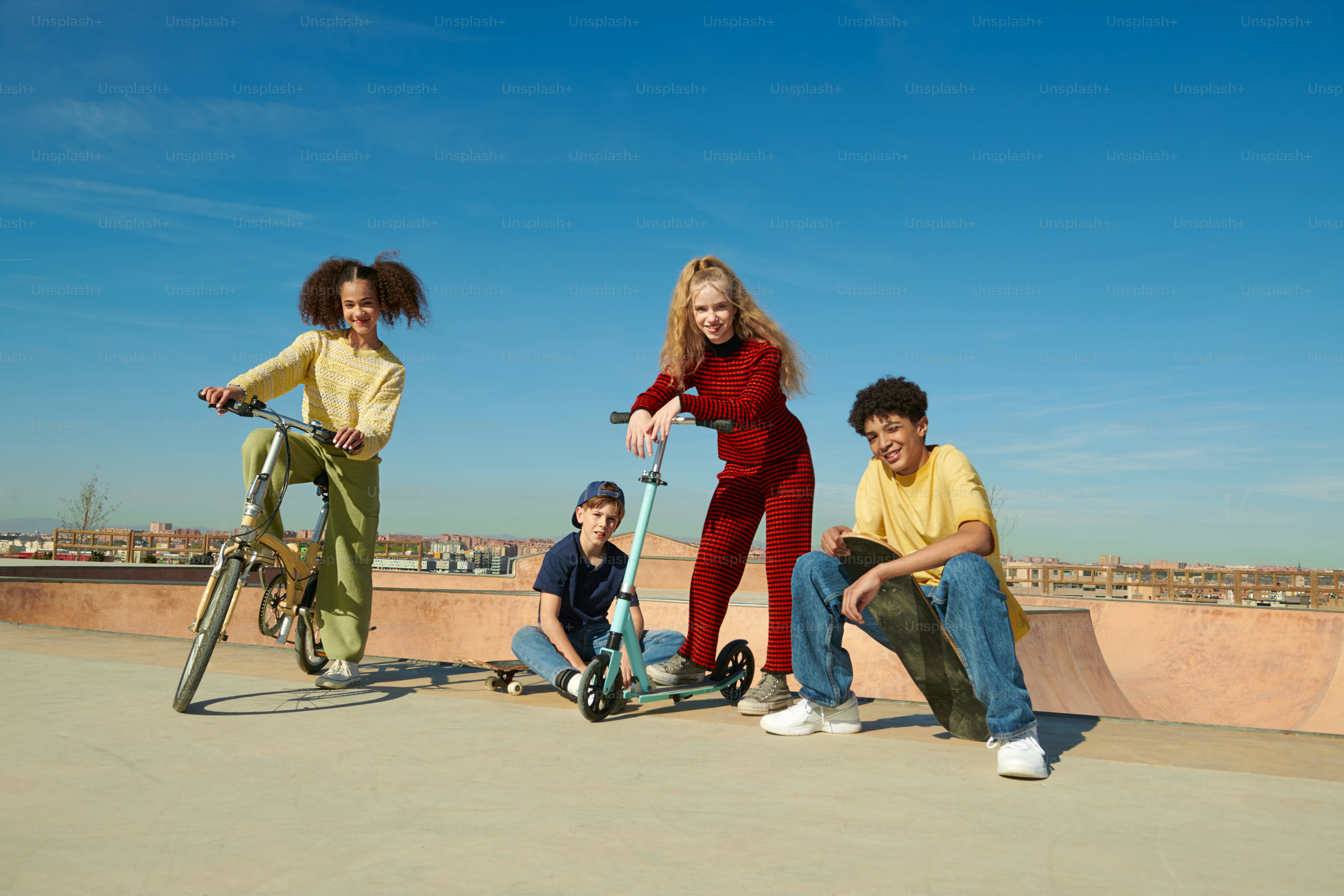 A group of young people riding bikes on top of a ramp photo – Friends ...