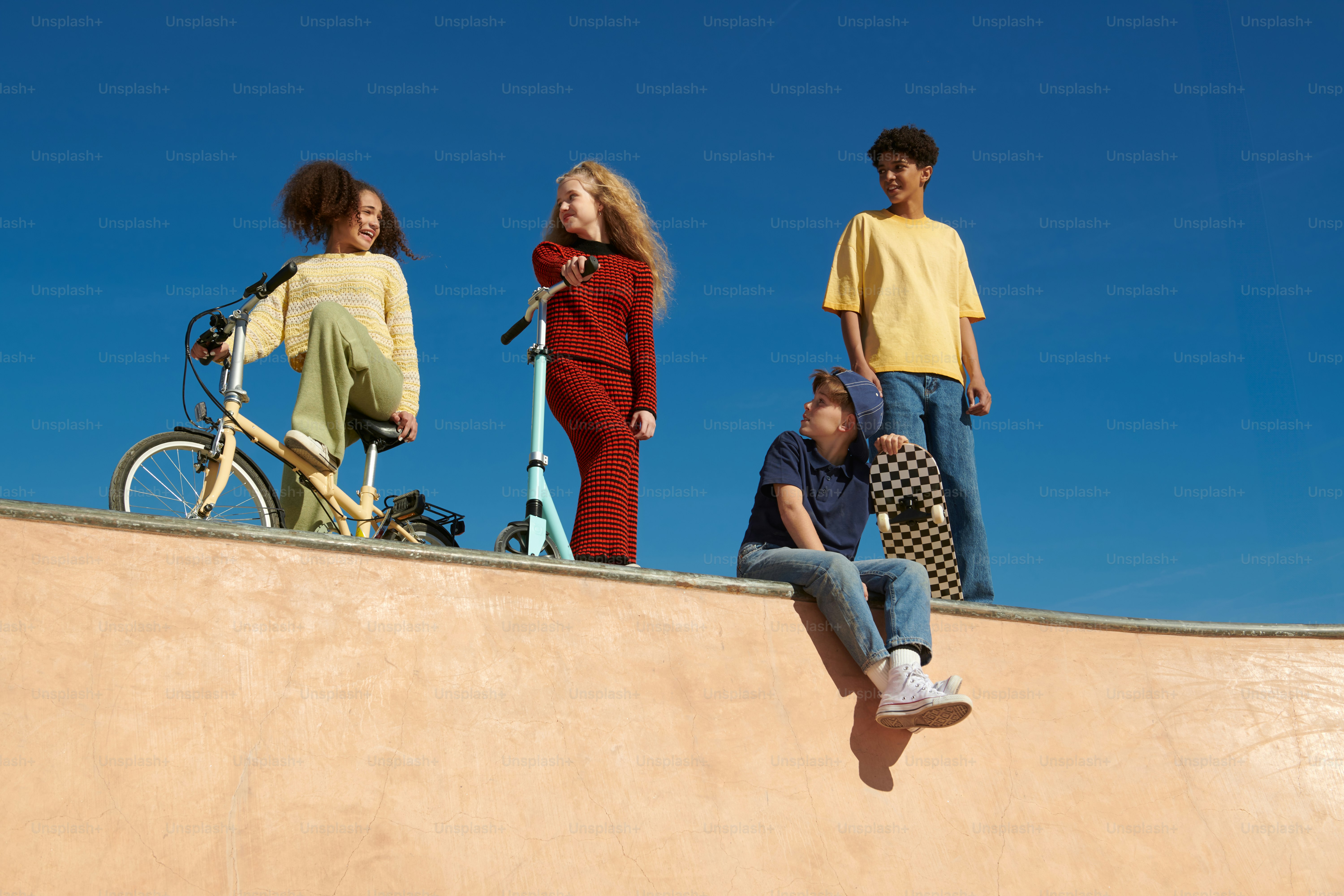 A group of people standing on top of a skateboard ramp photo – Friends ...