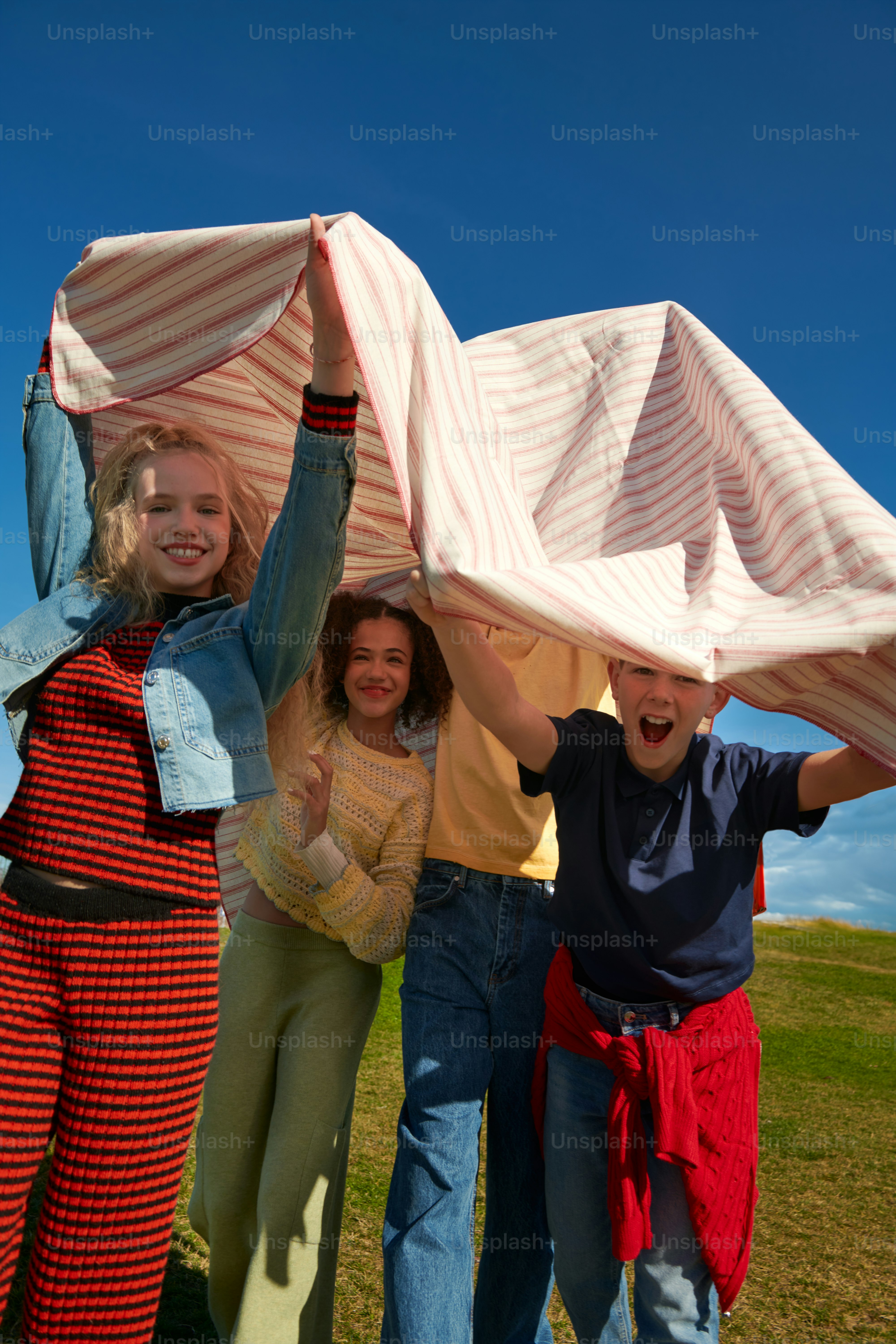 A group of people carrying a large object over their heads photo ...